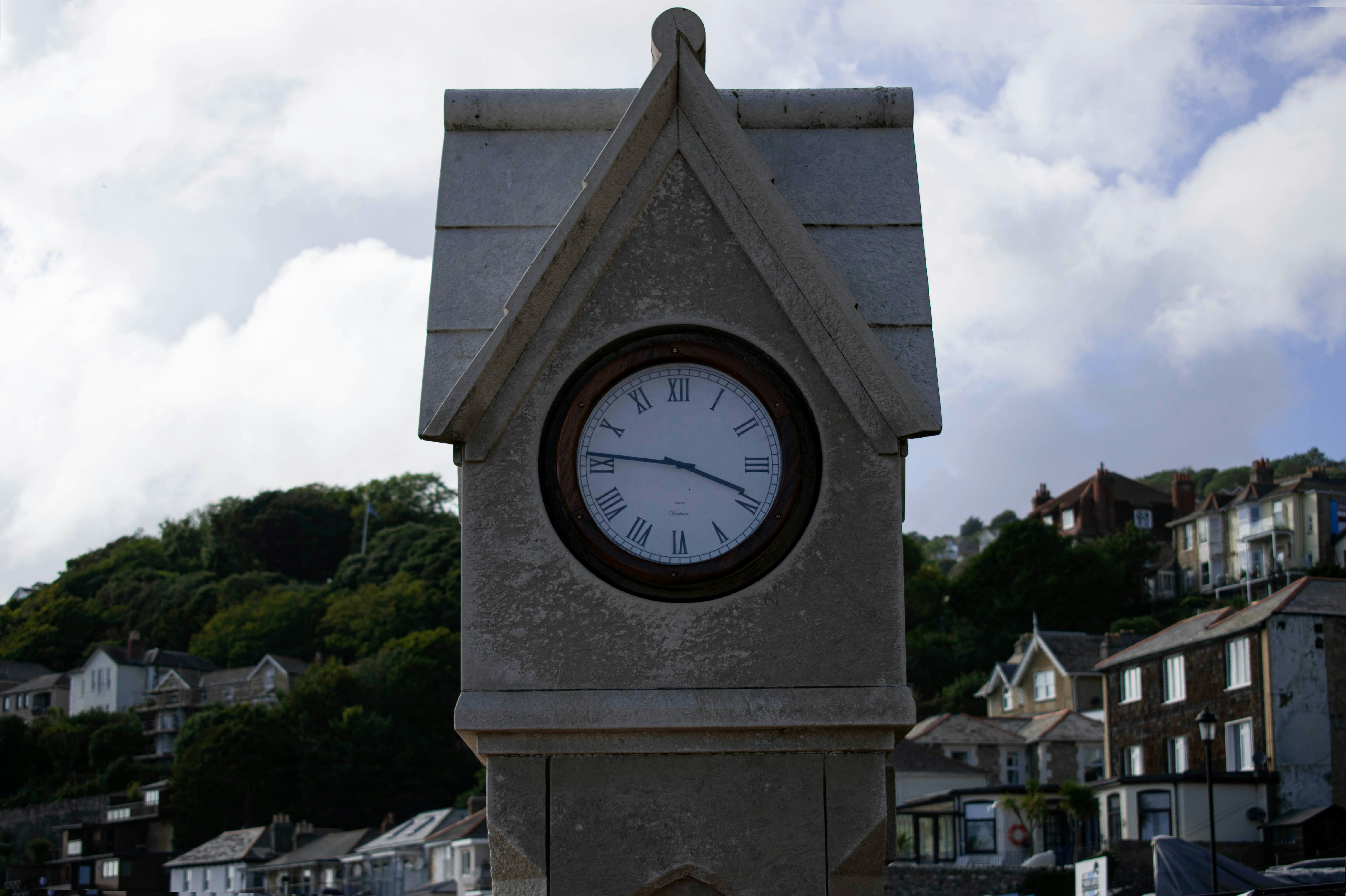 Weathered Clock Tower Over a Terraced Coastal Town