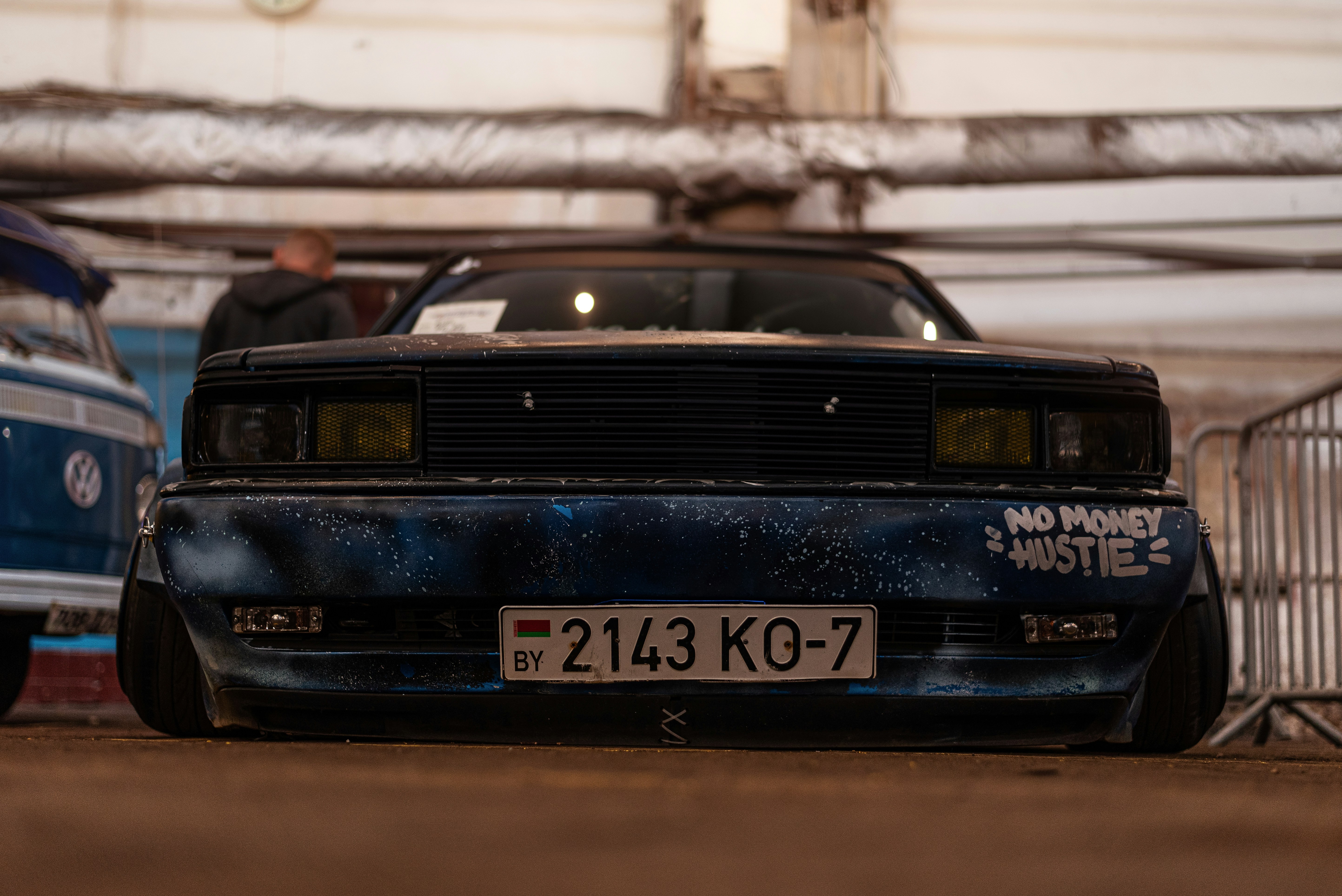 No Money, No Hustle: Front-End Stance of a Blue Street Machine in a Dim Workshop
