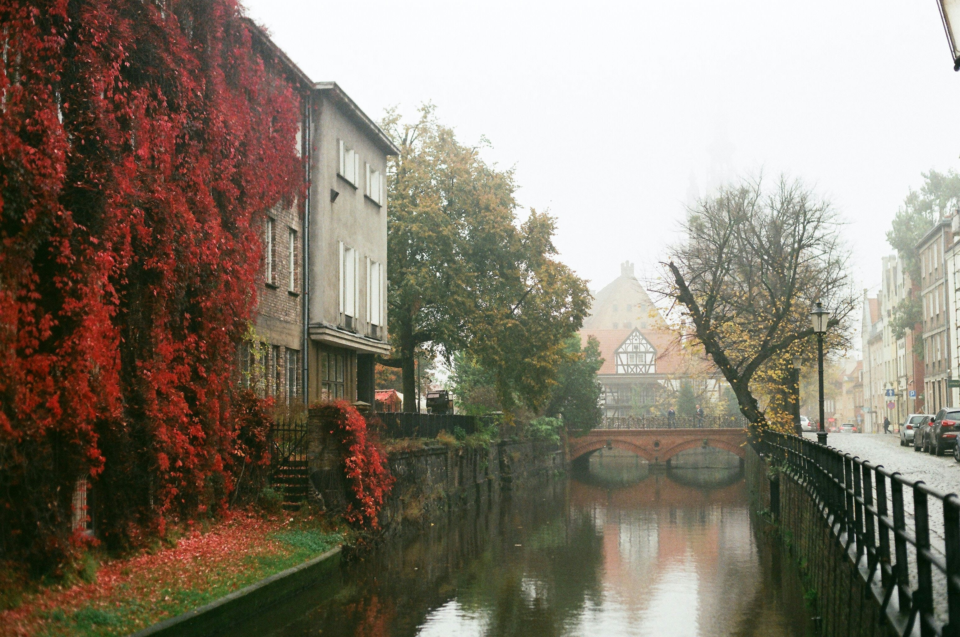 A canal with a bridge and buildings photo – Free Archicture Image on ...