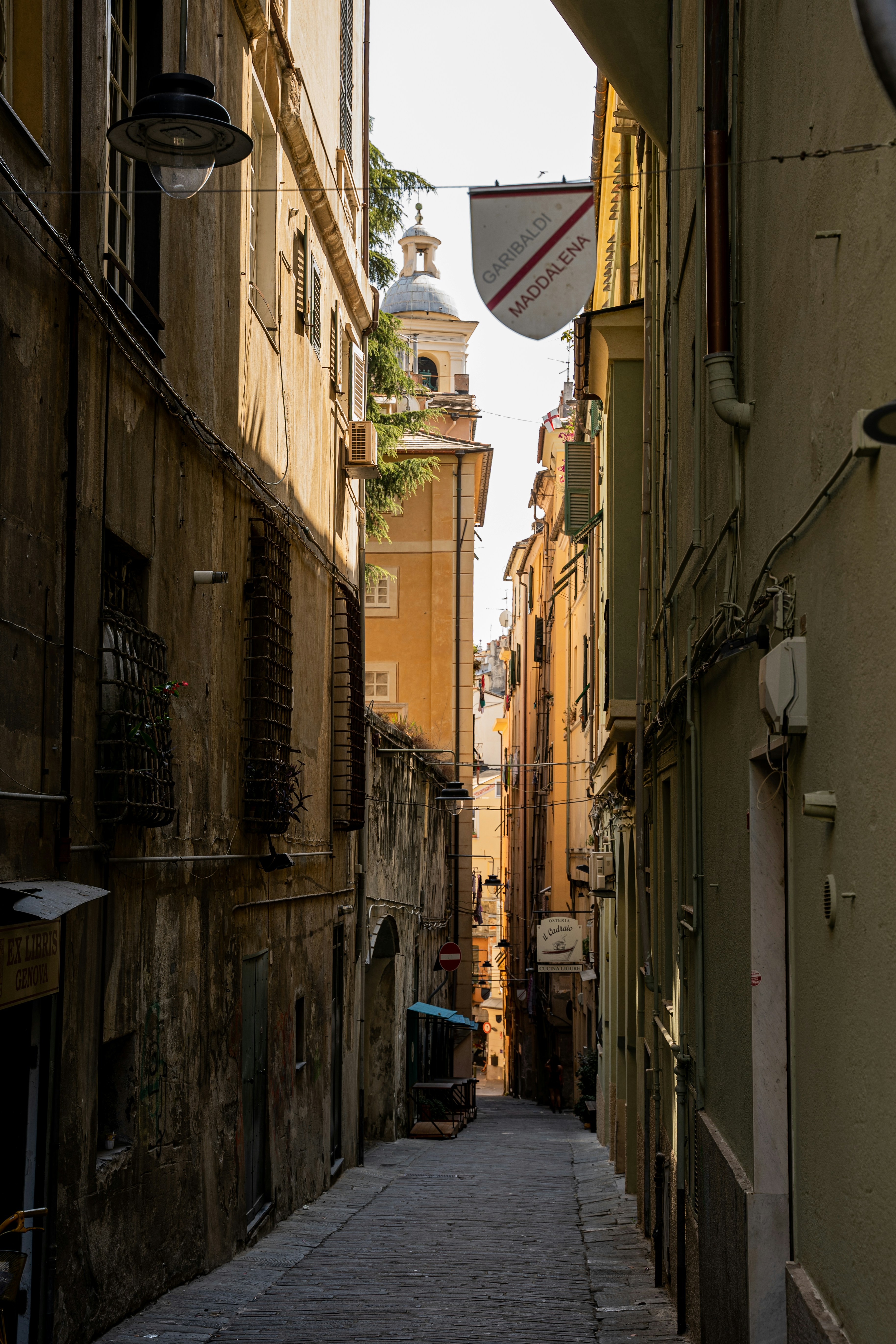 End of the Alley: Sunlit Gateway Through a Timeworn Mediterranean Street