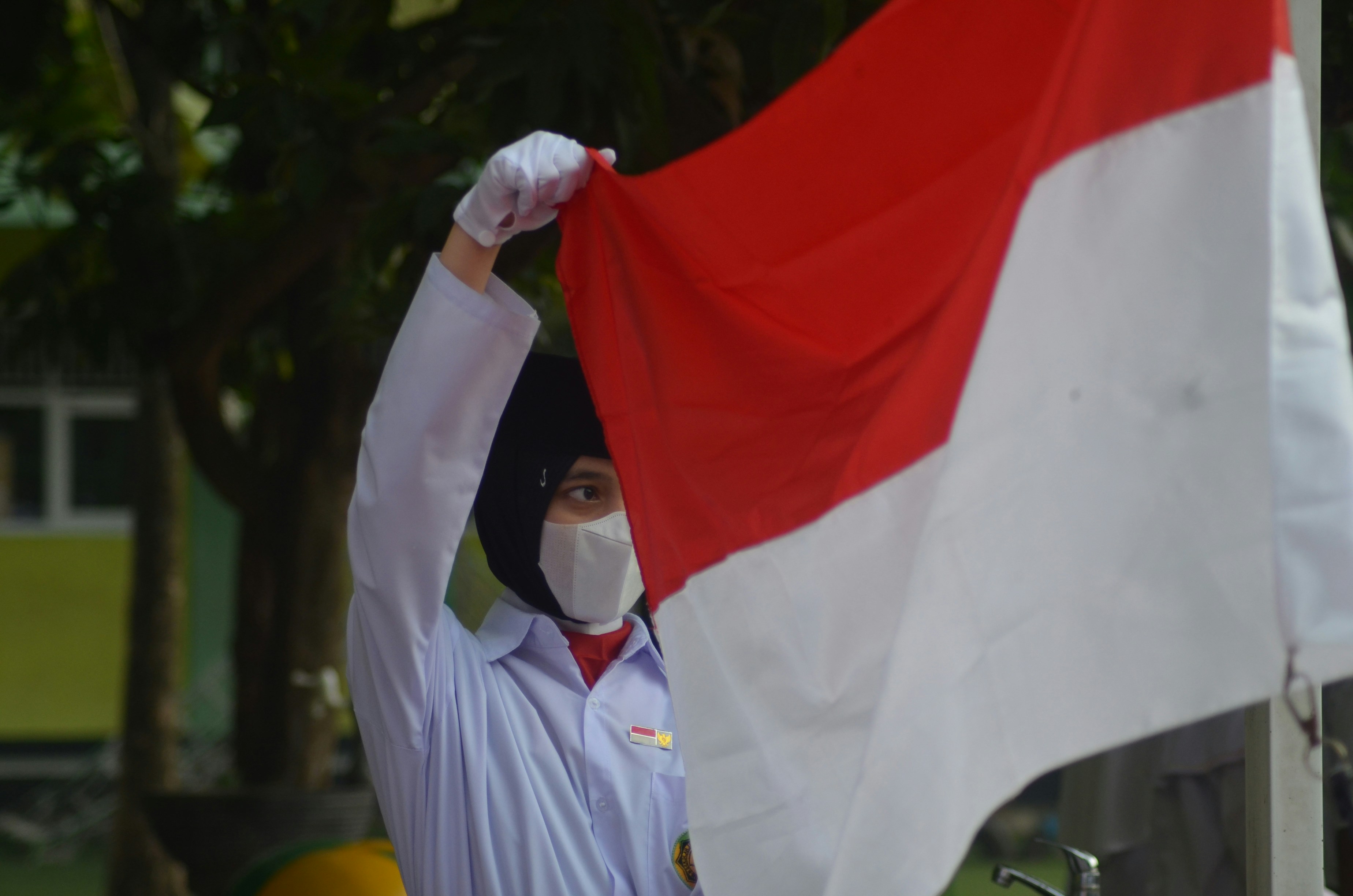 a woman waving the indonesian flag
