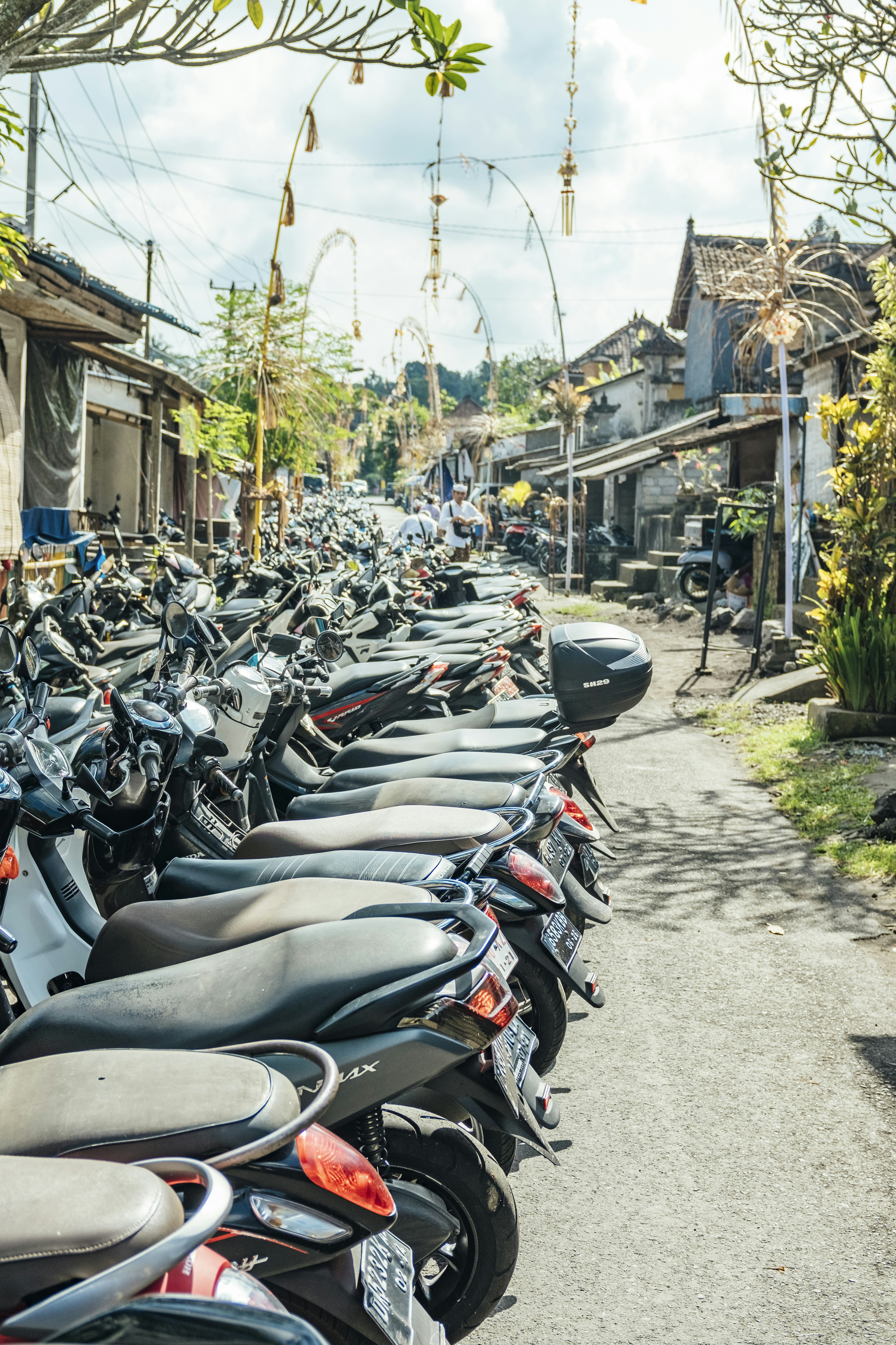 Scooter Row: A Narrow Village Street Framed by a Sea of Motorcycles