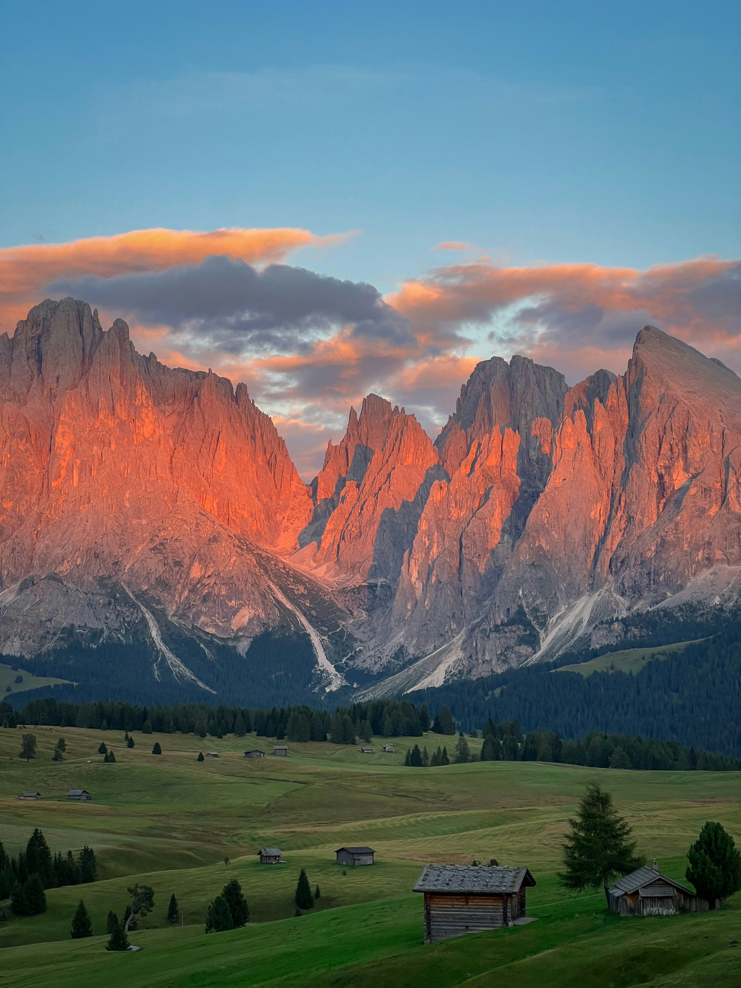 Crimson Peaks at Dusk Over a Gentle Alpine Meadow