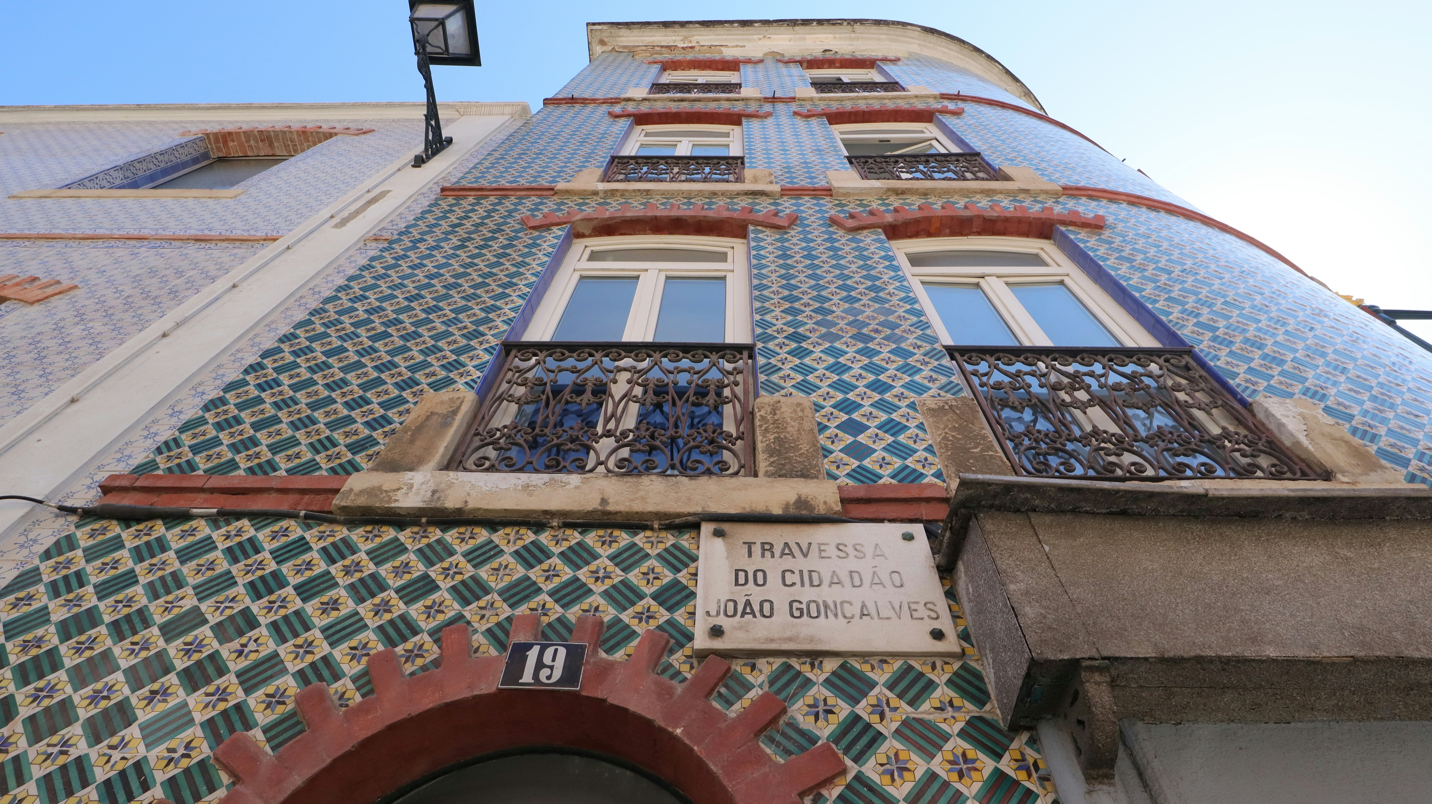 Azulejo Echo: Low-Angle Portrait of a Tile-Woven Lisbon Facade
