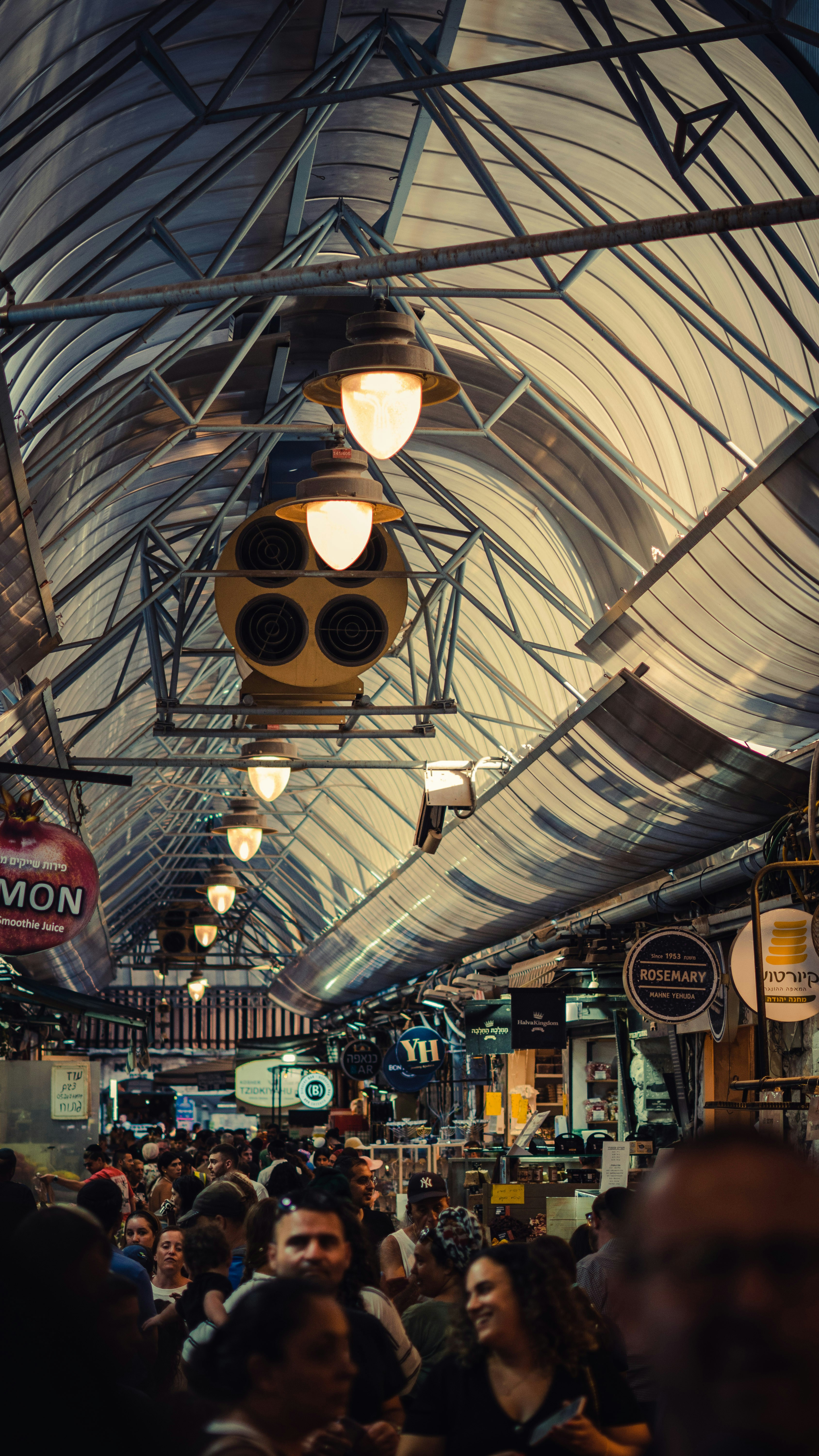 A large crowd of people in a large room with many lights photo – Free ...