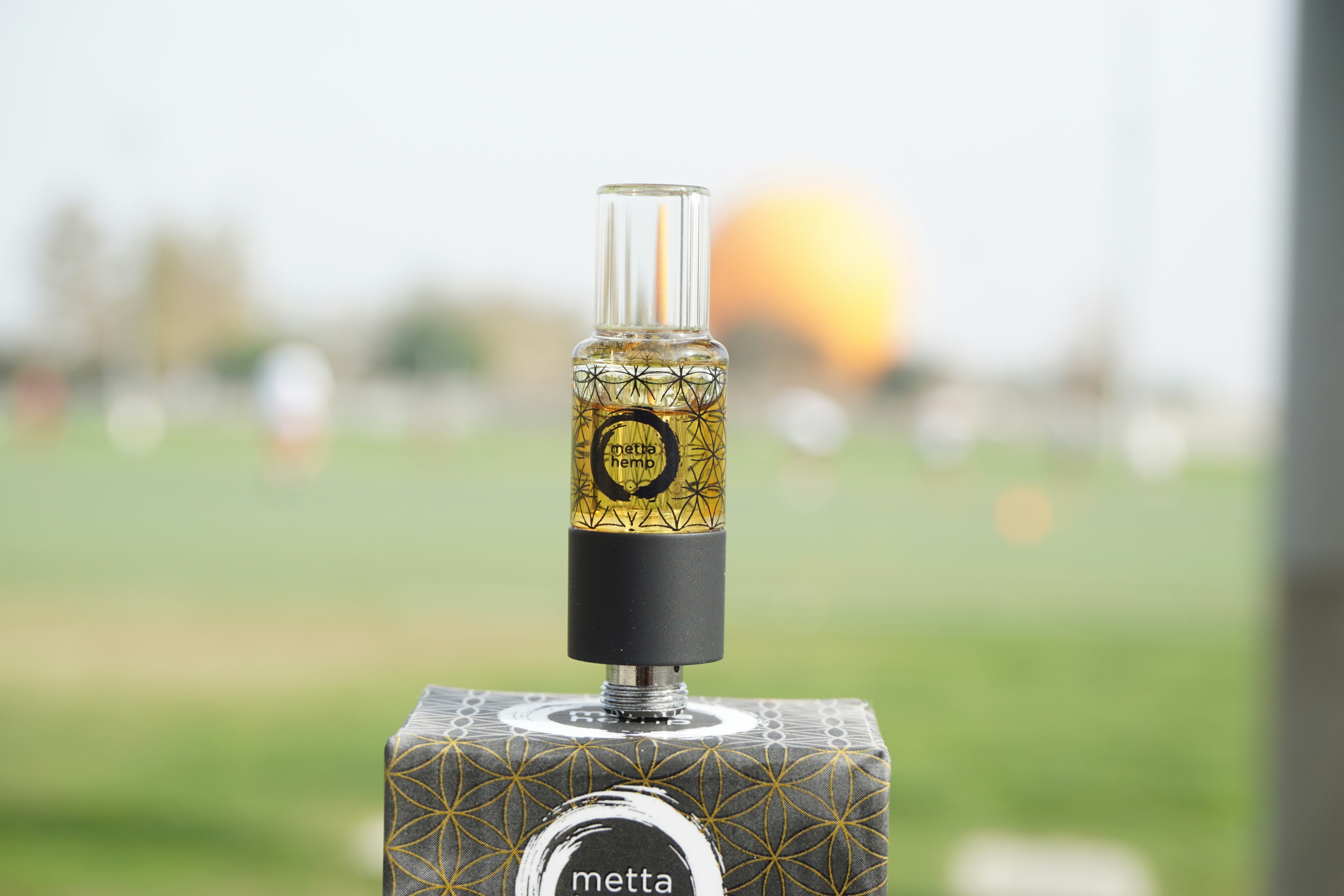 Liquid Glow: A close-up on a glass atomizer atop a patterned box