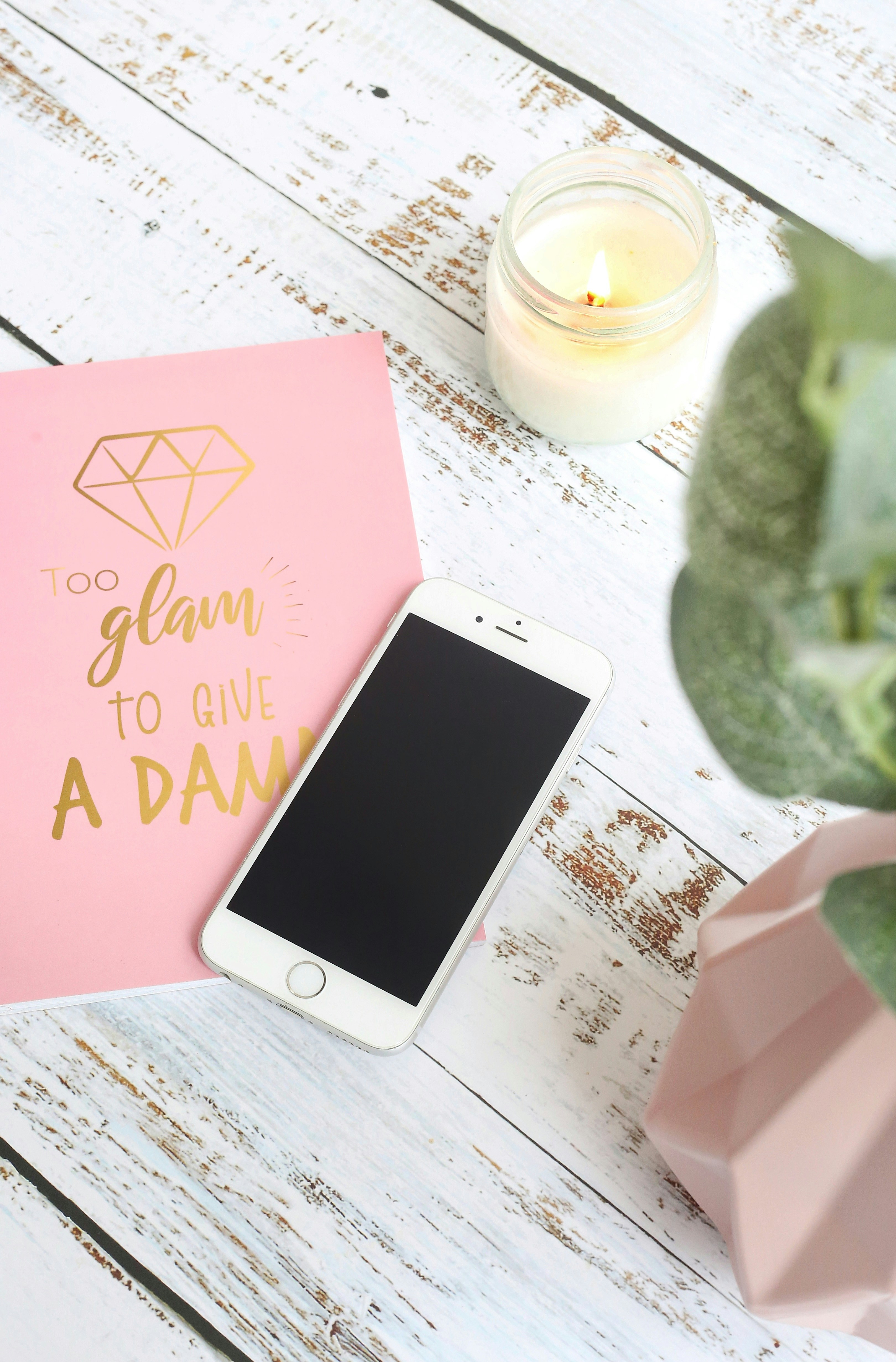 Soft pink stationery and glowing candle: a chic desk vignette