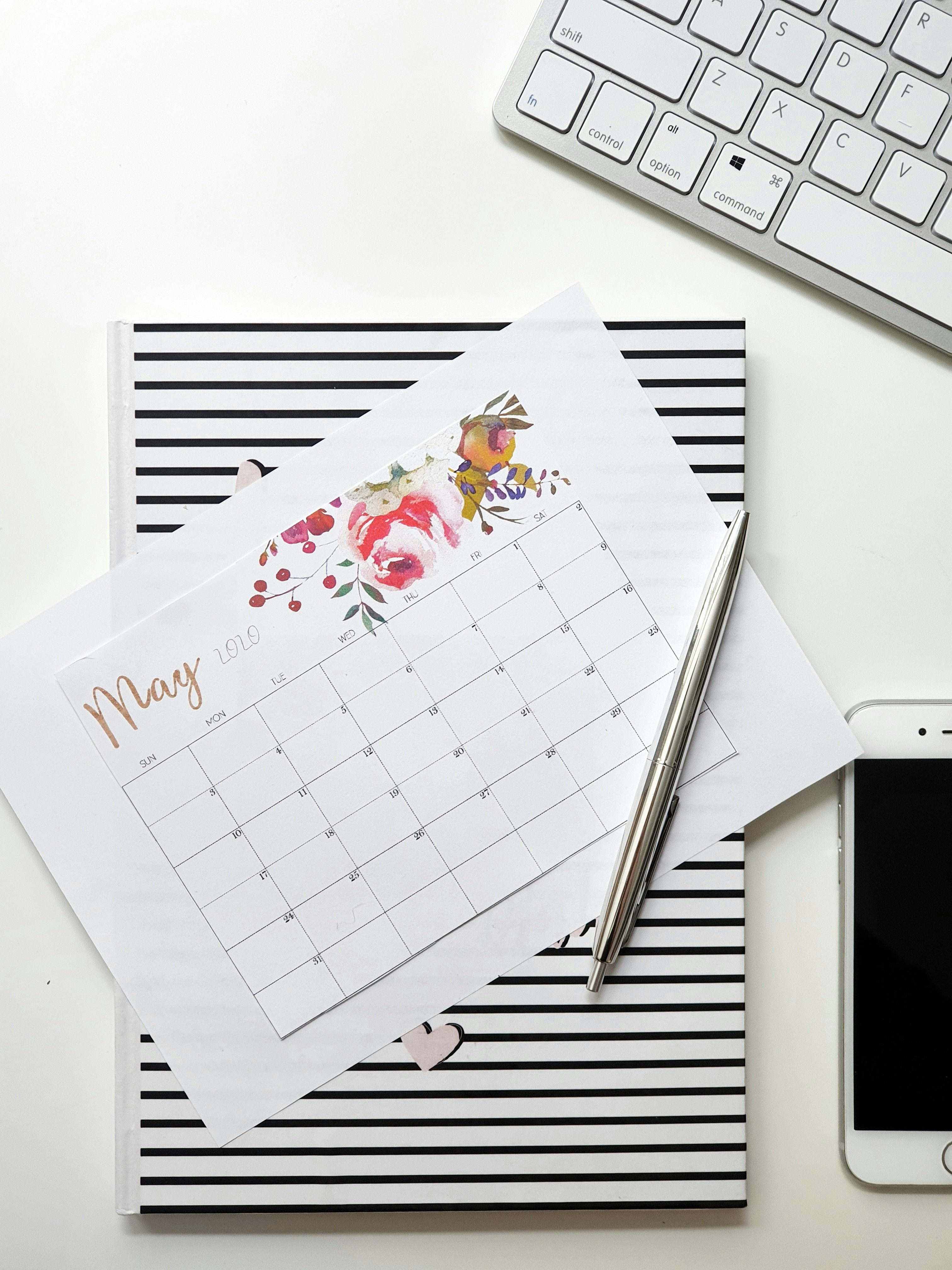  Organized desk with calendar and pen on striped notebook