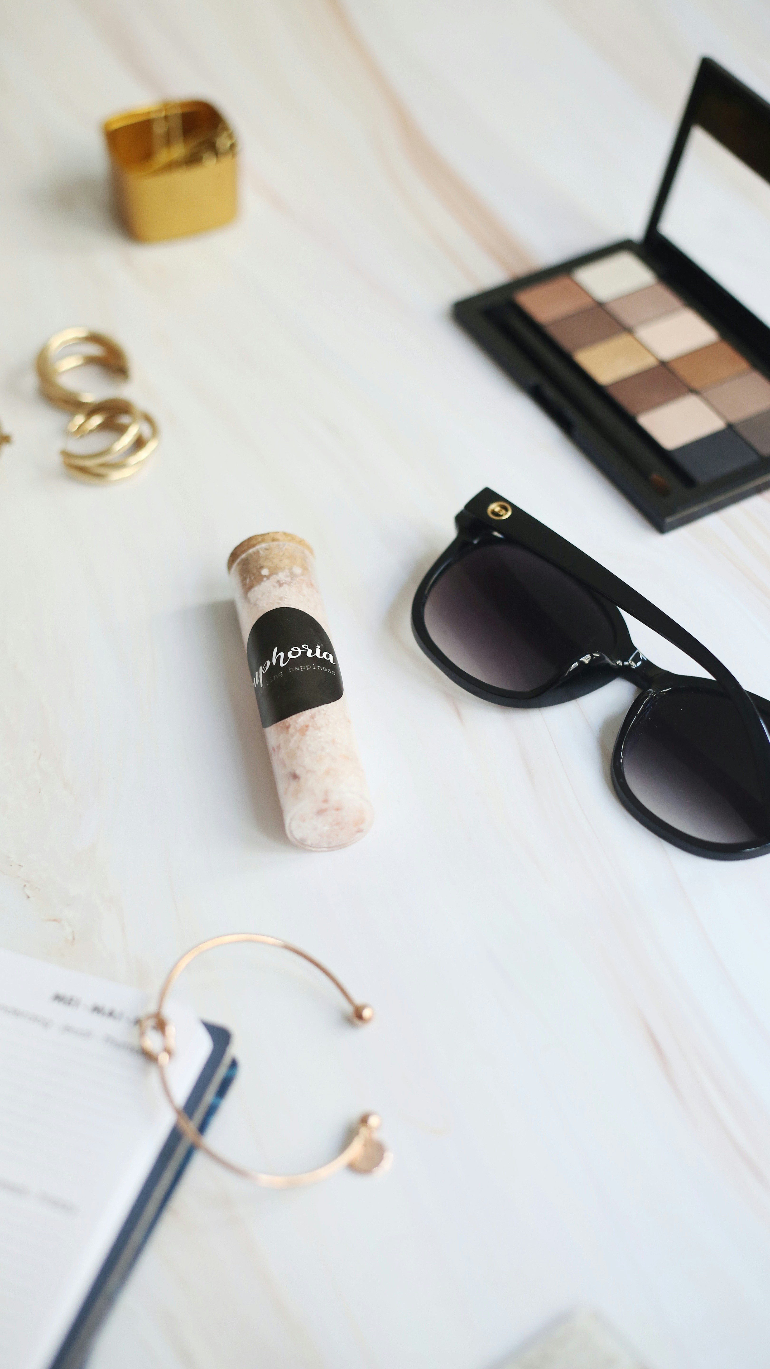 Sleek Everyday Essentials Spilled Across Marble White