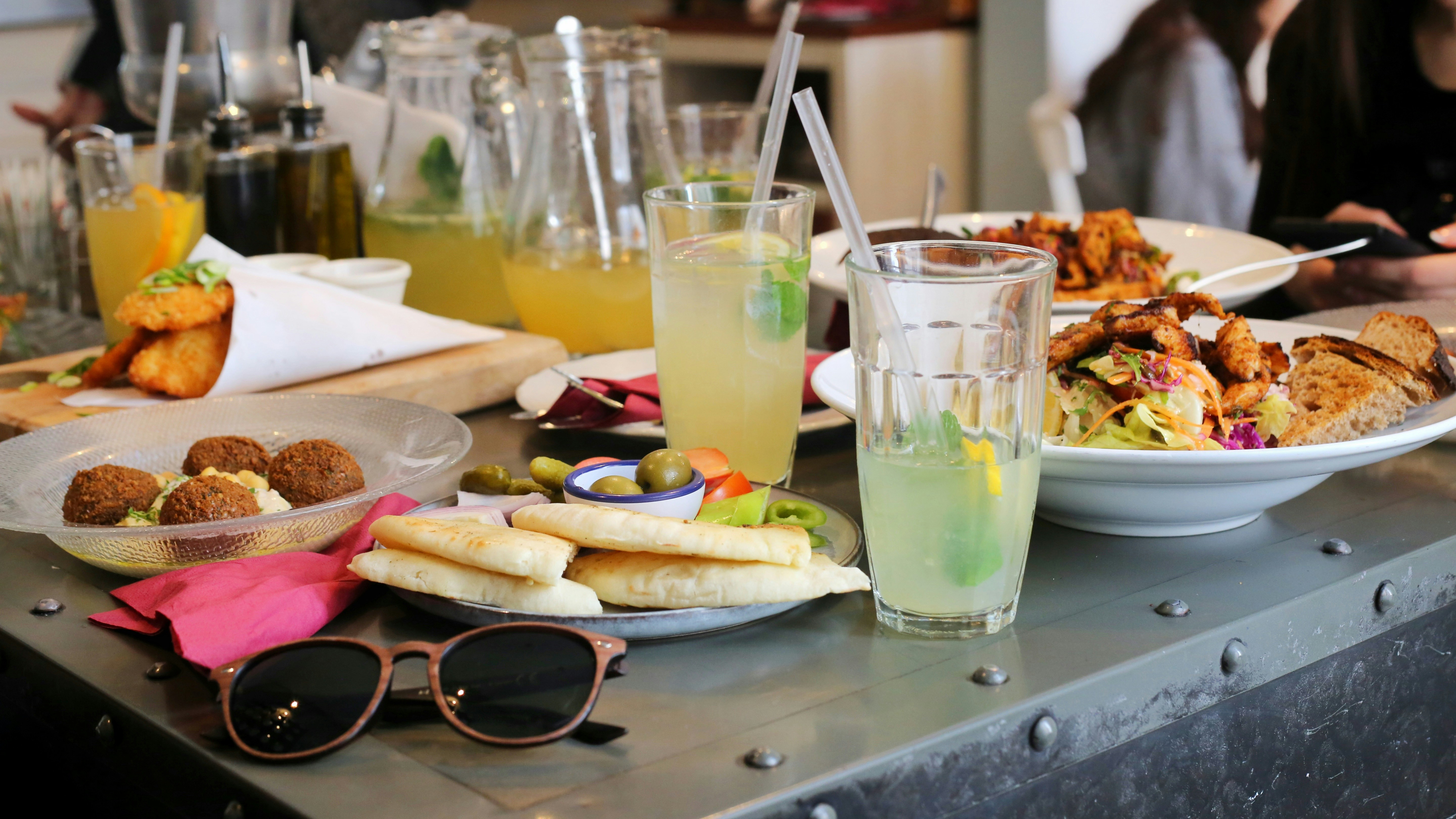 Grazing Table Under Café Lights: Crispy Bites and Citrus Refreshments