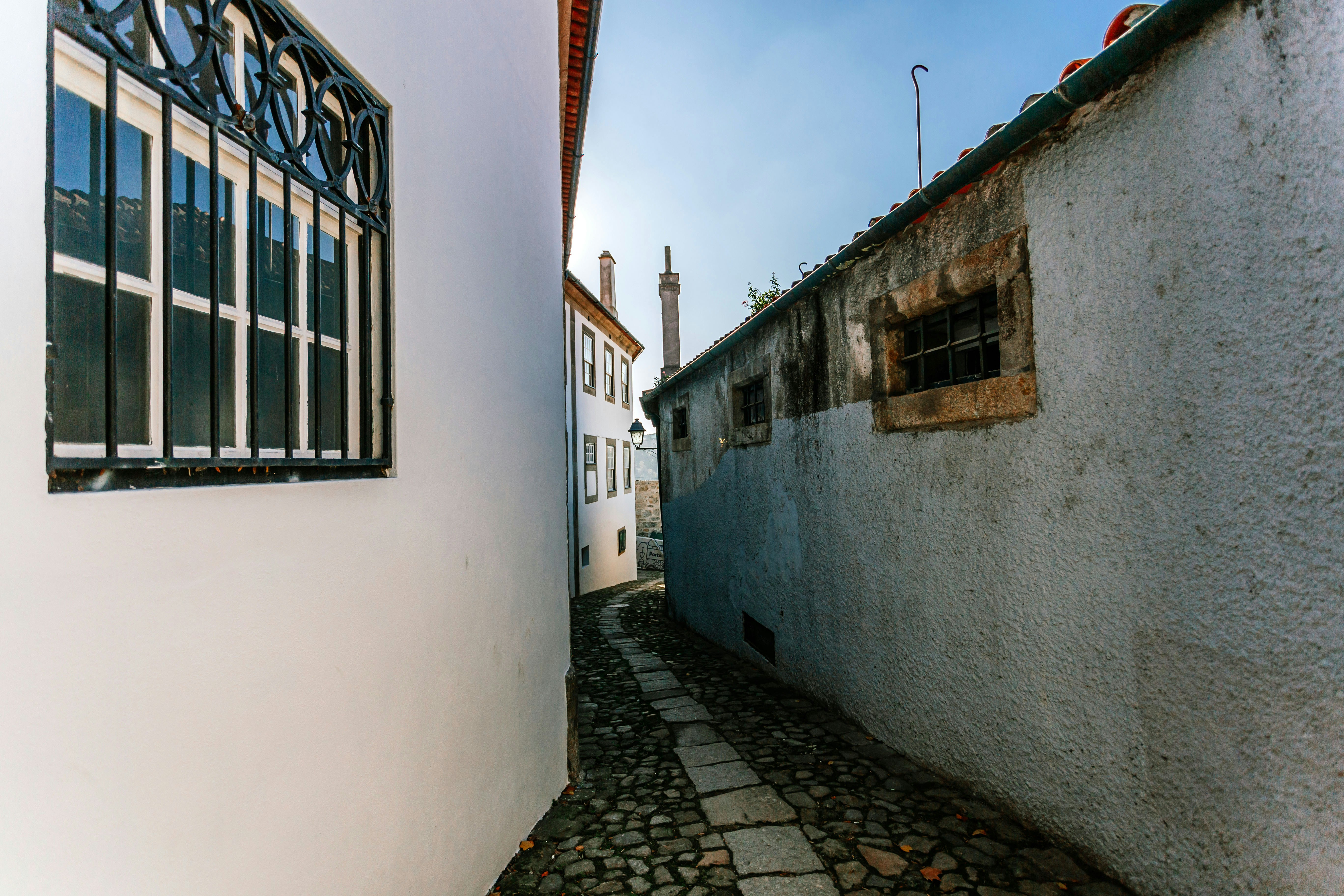 A cobblestone street between two buildings photo – Free Building Image ...