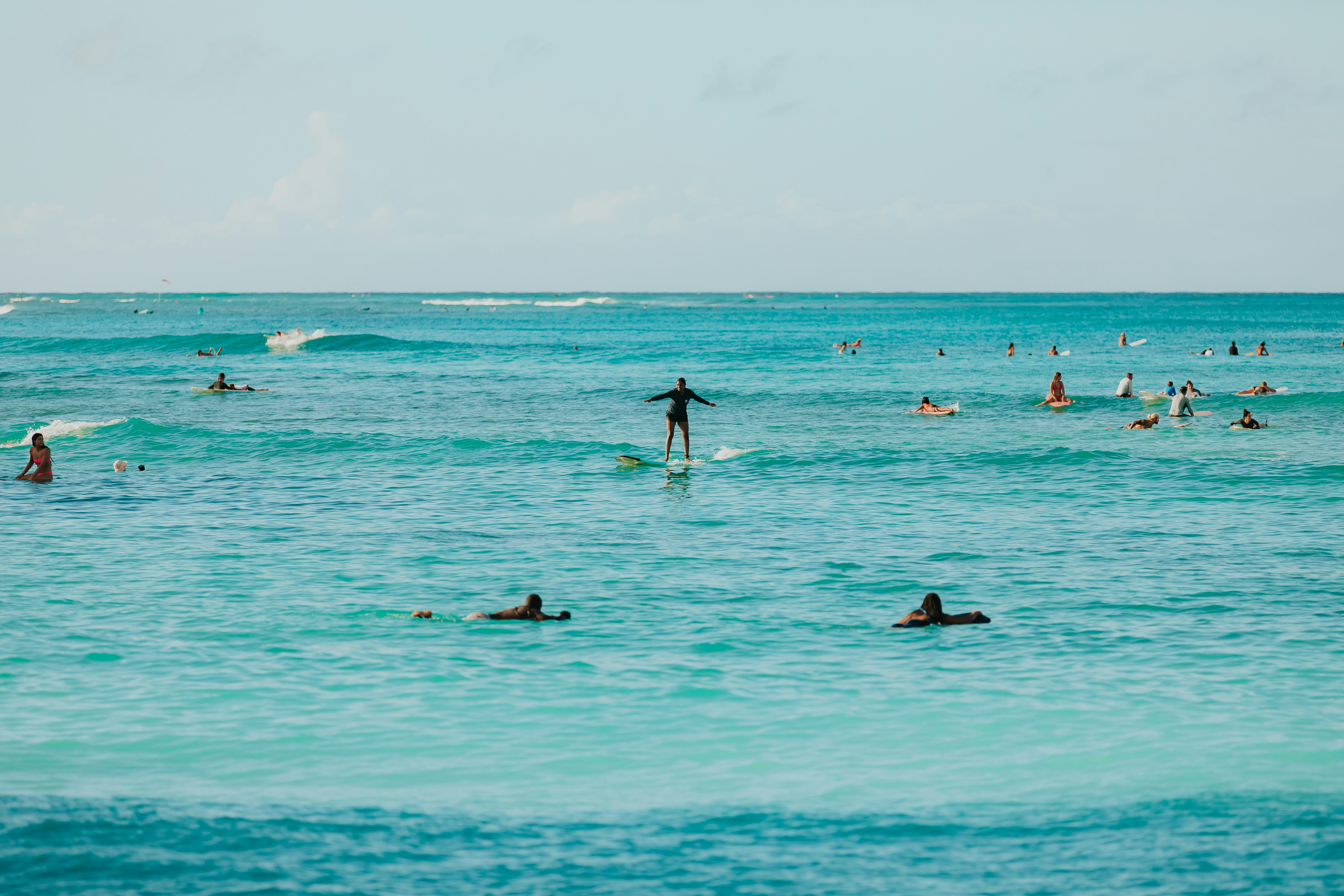 A group of people surfing in the sea photo – Free Blue Image on Unsplash