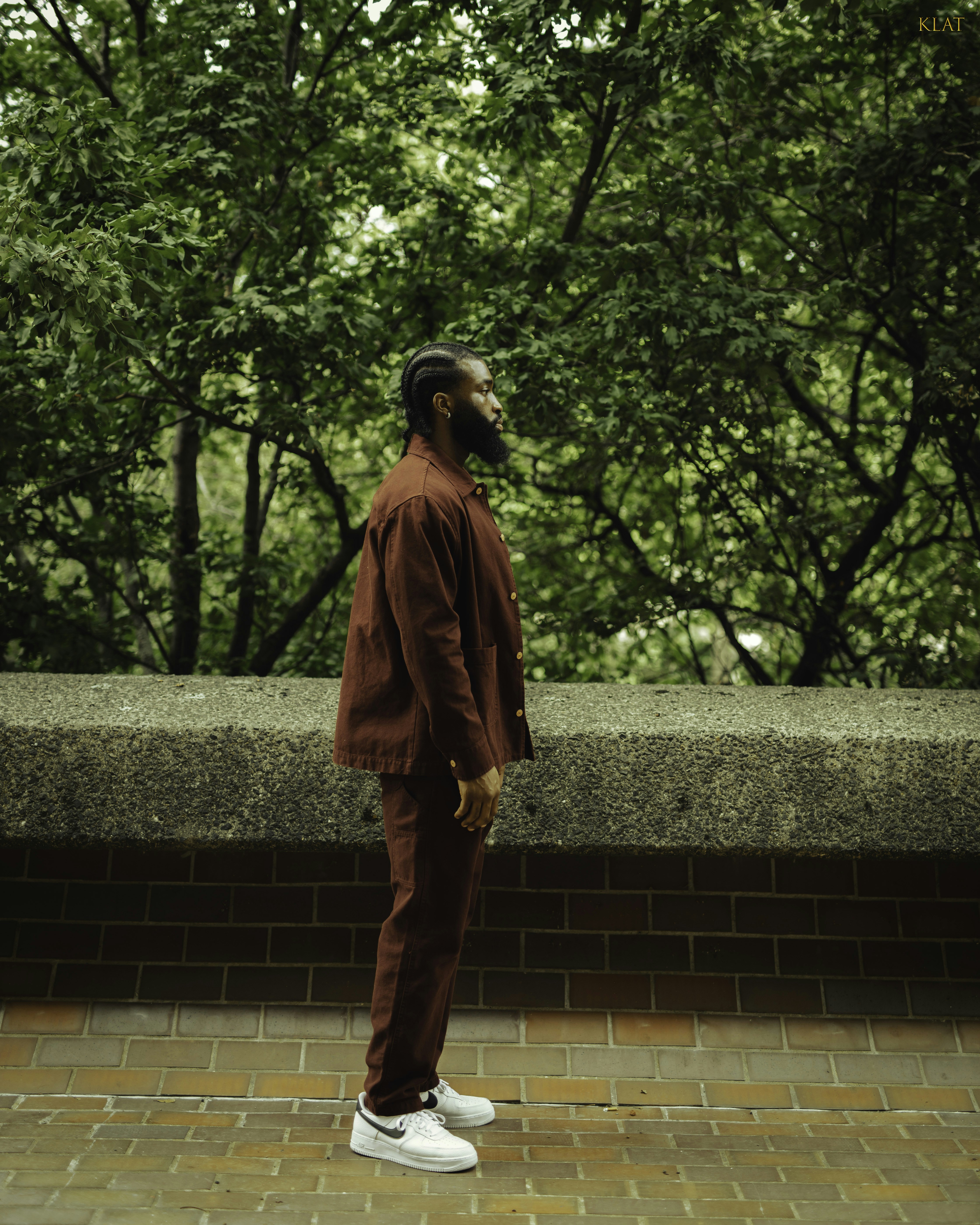 Crimson Quietude: A Side Portrait Among Green Canopy