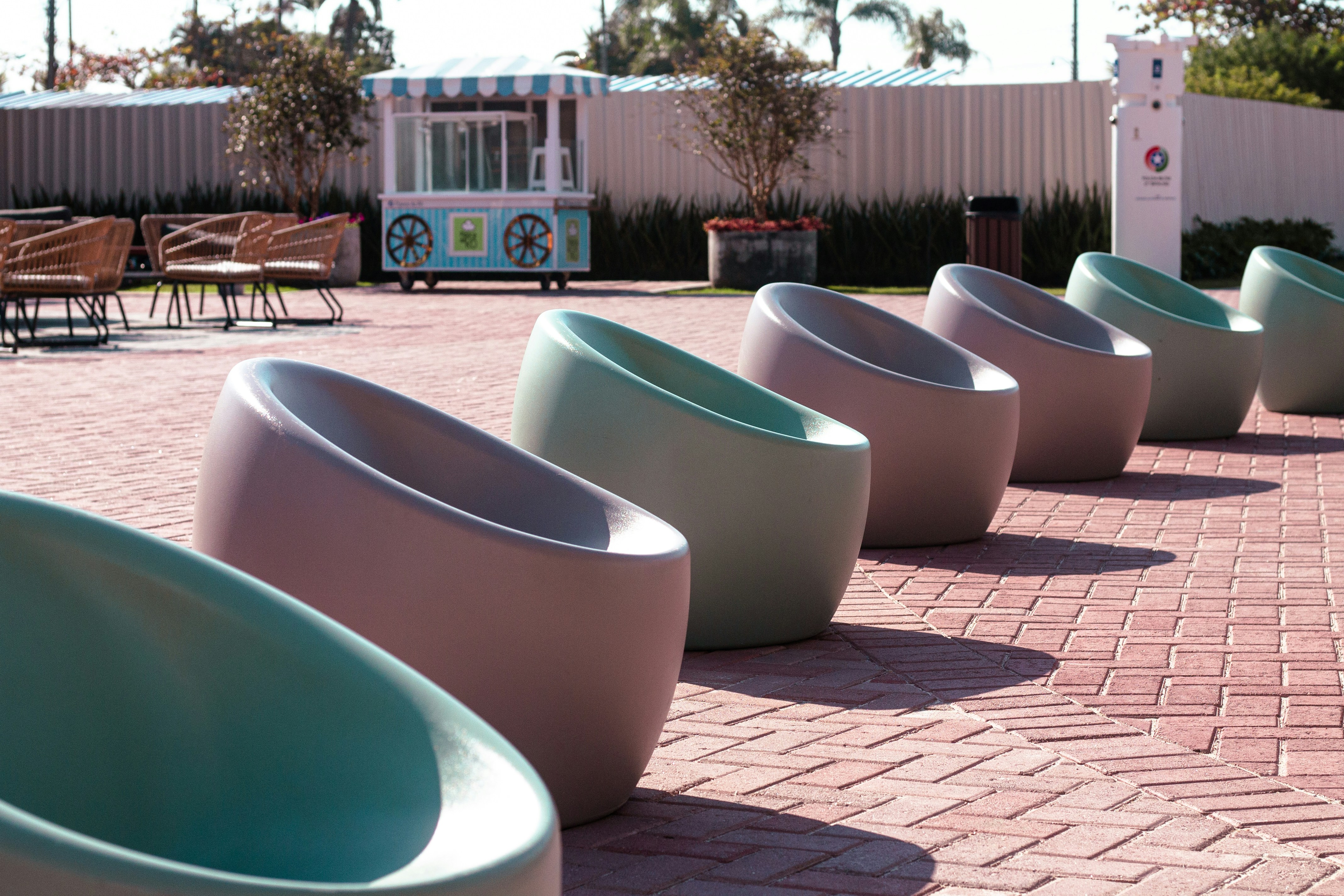 Pastel Pods in a Sunlit Courtyard: Loungers in a Row