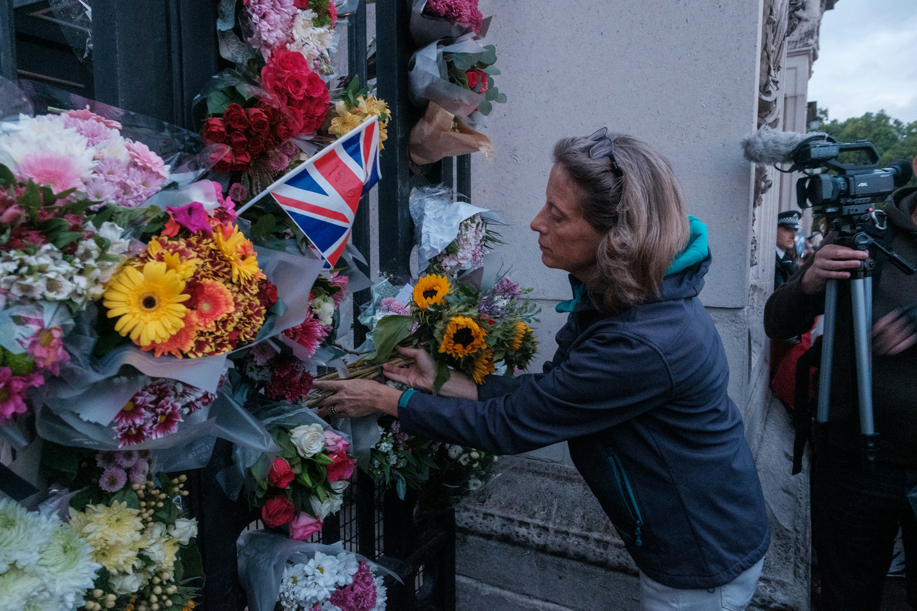 Bouquets and Flags: A Moment of Tribute at the Memorial Wall