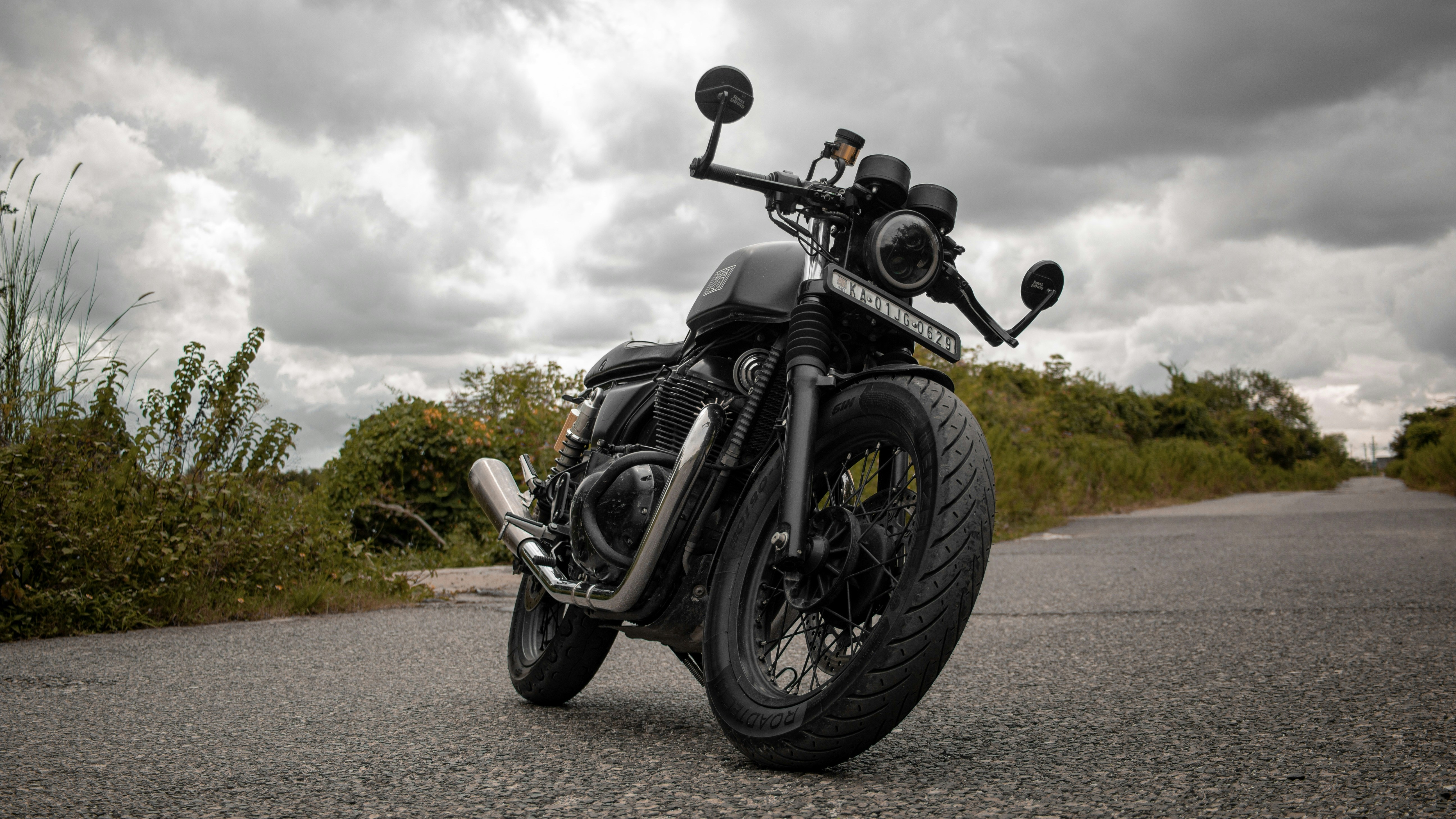A motorcycle parked on a road photo – Free Wallpaper 4k Image on Unsplash