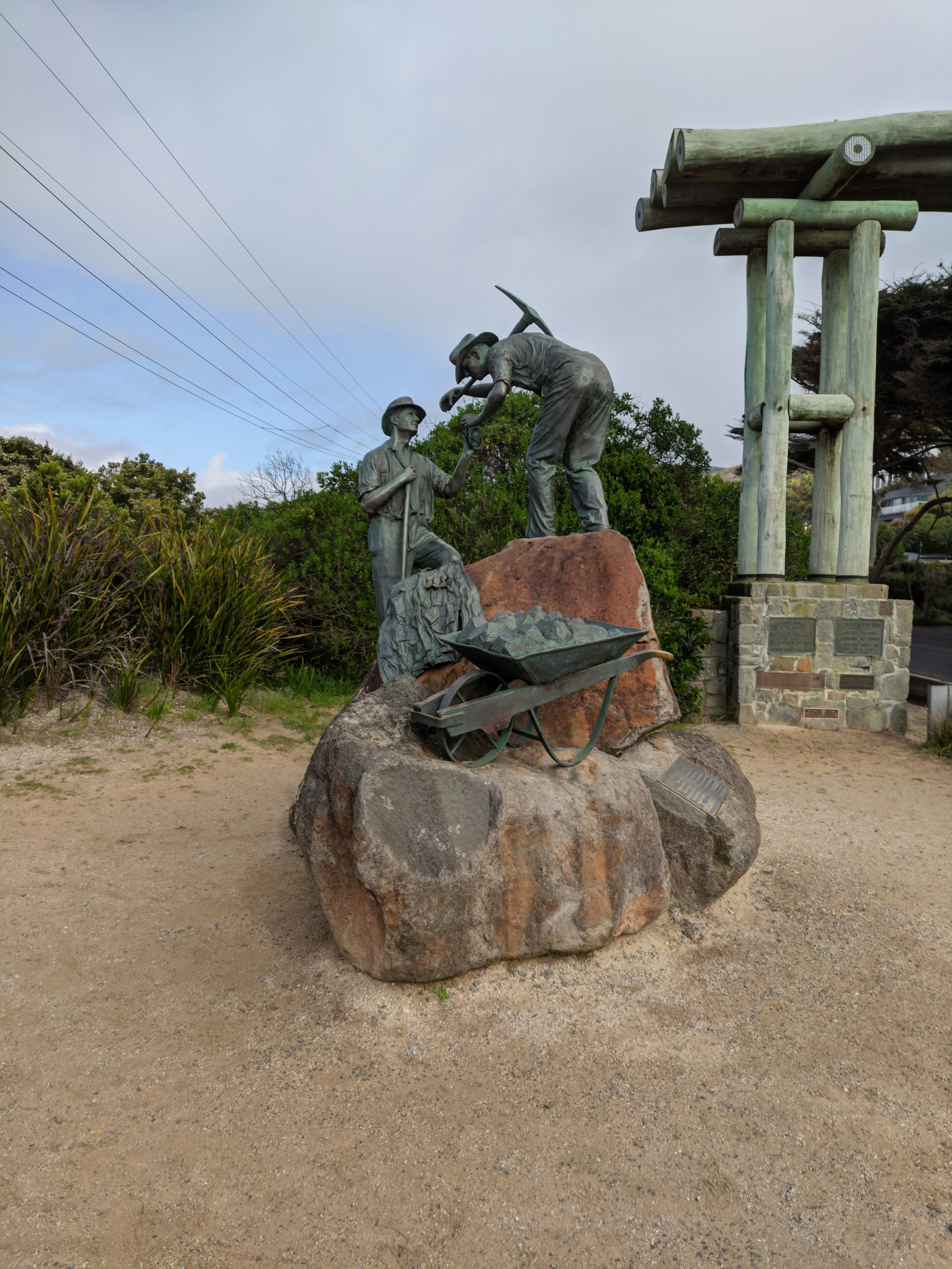 a statue of a man and a woman on a rock