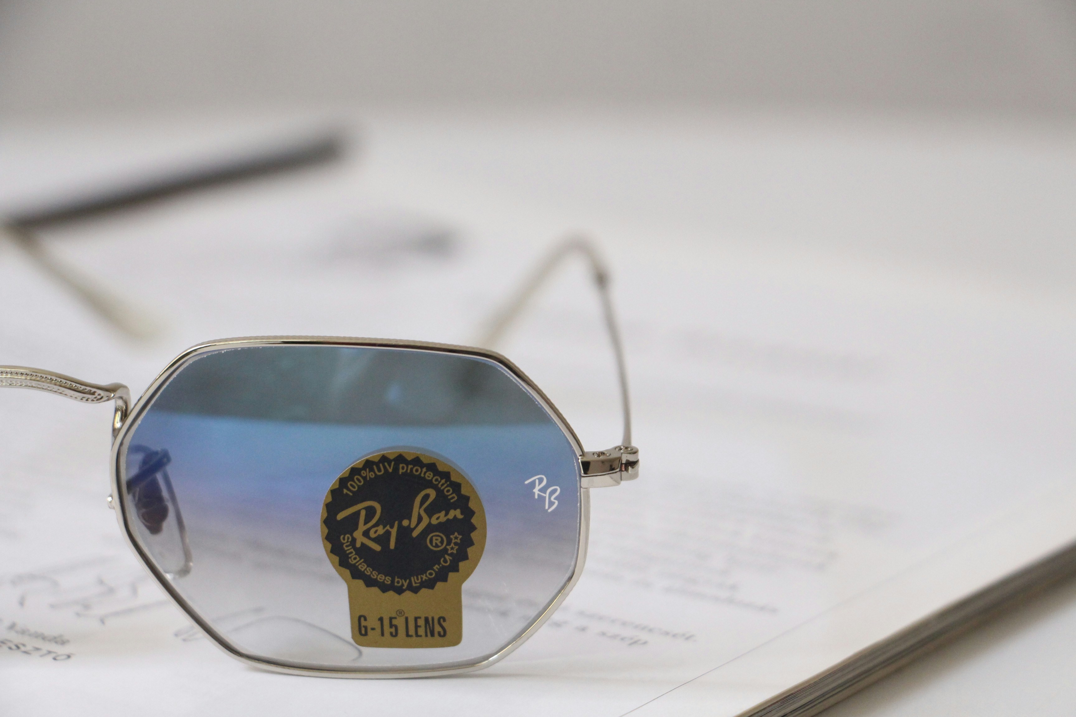 Ray-Ban G-15 Lens Resting on Open Pages: A Minimal Study Moment