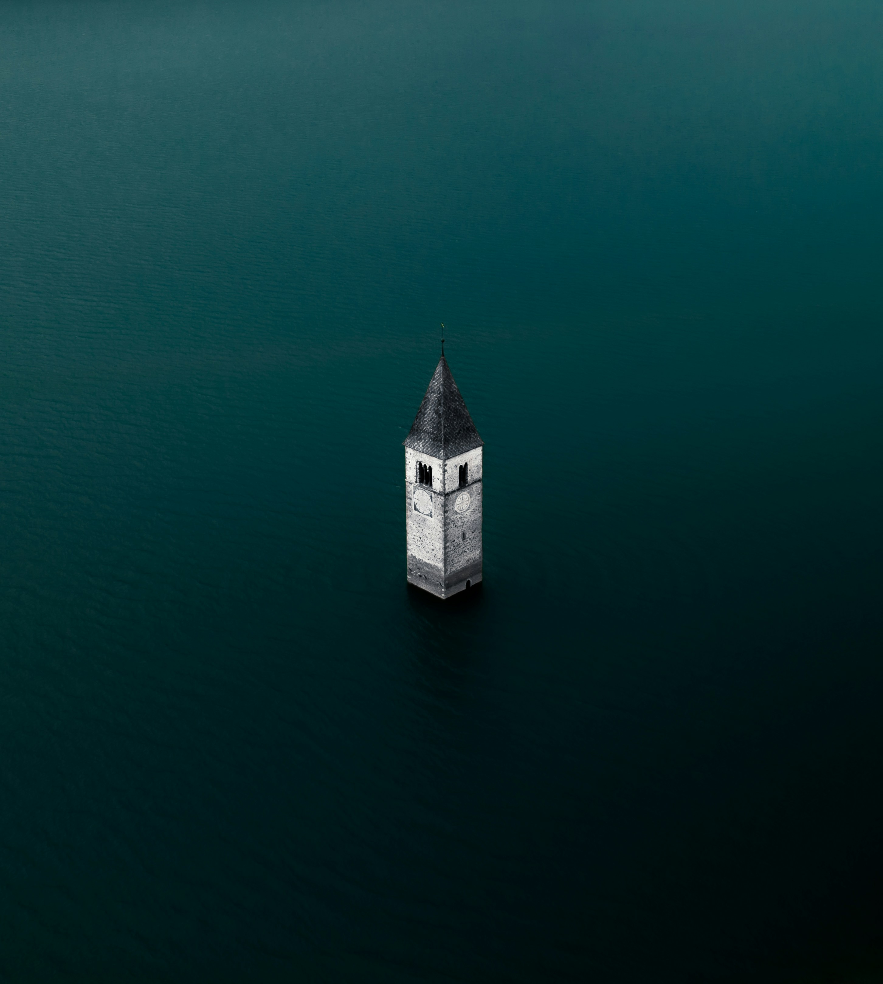 Lonely Bell Tower Poised in Quiet Teal Waters