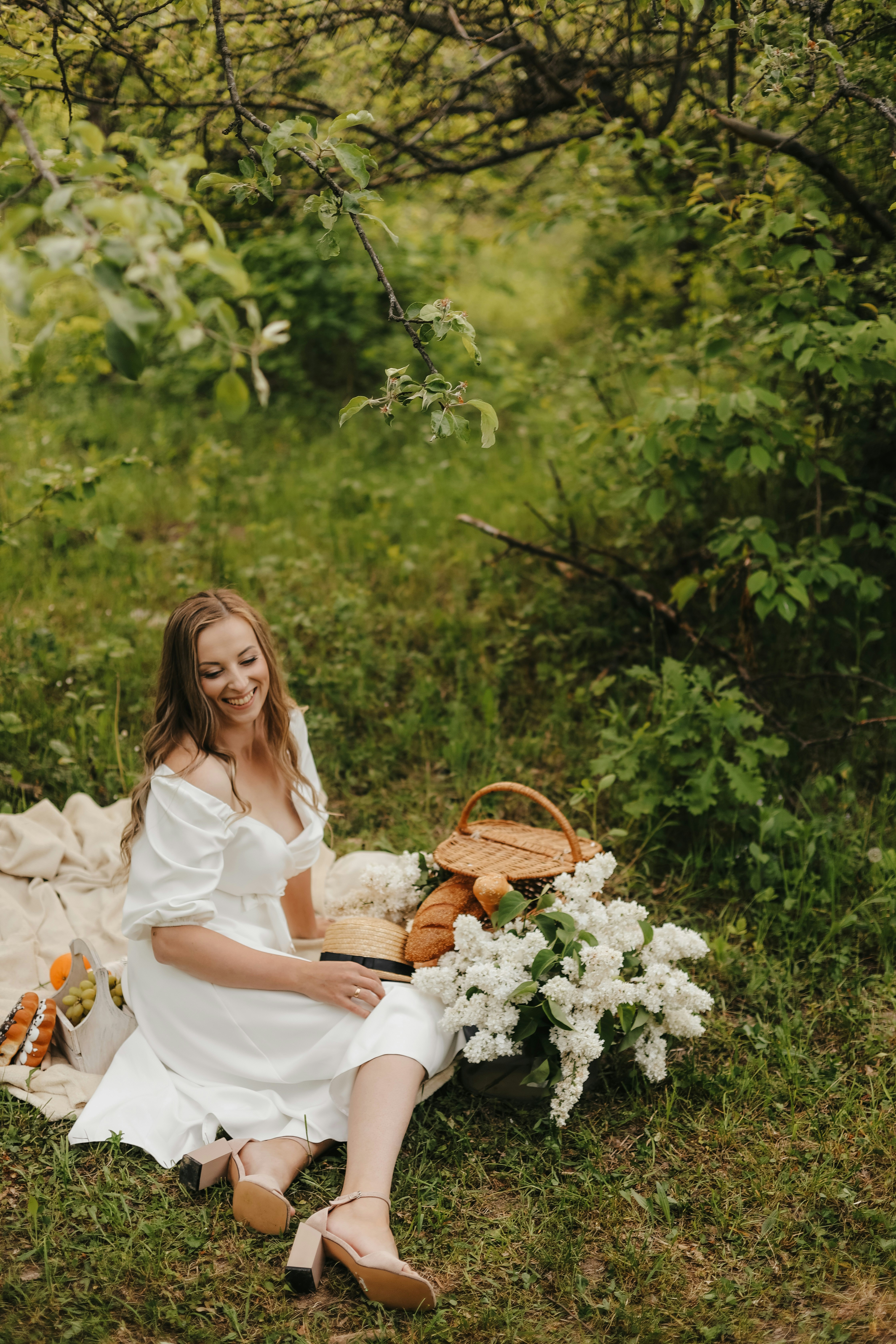 a woman sitting on a bench with a basket of flowers