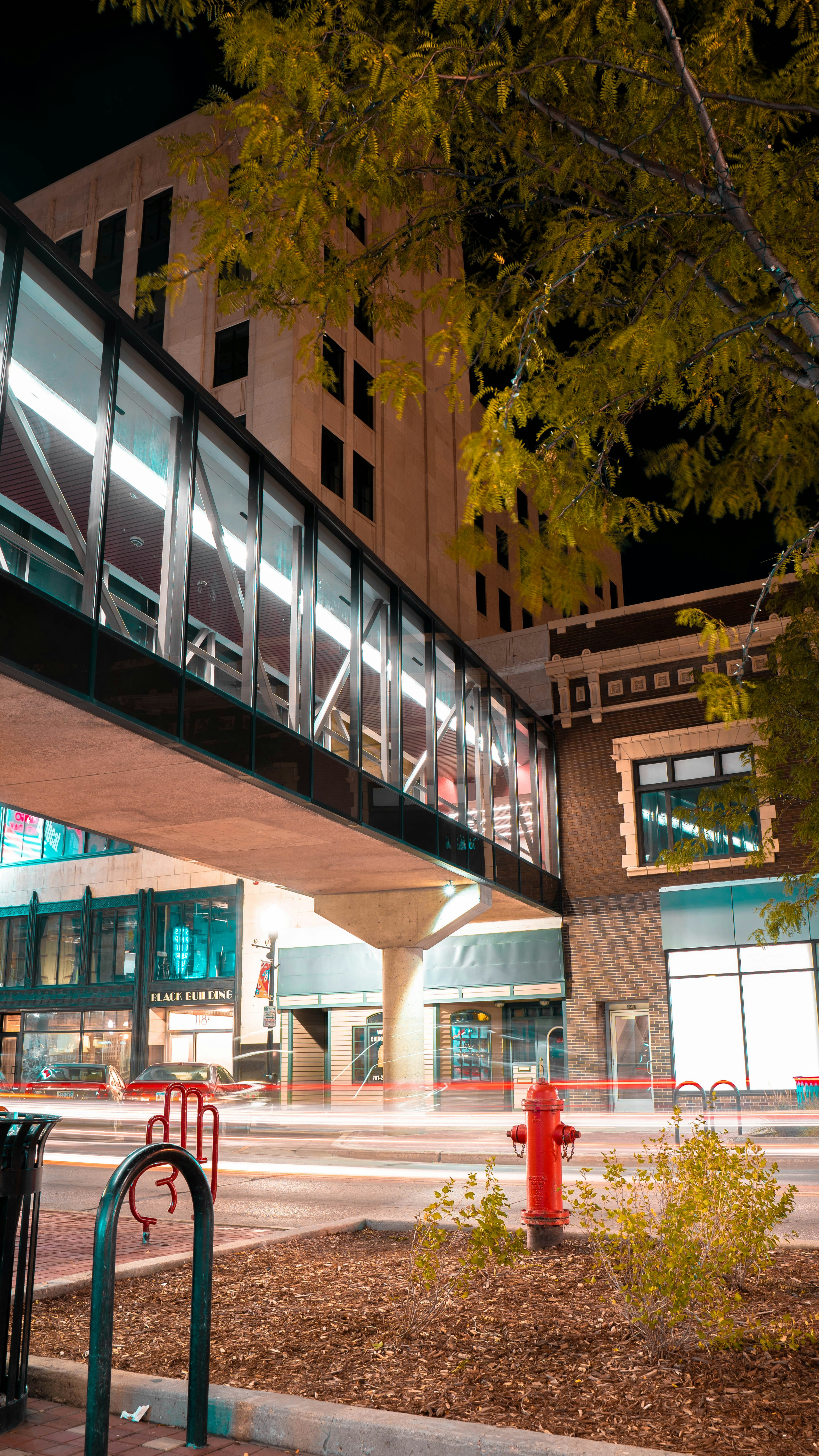 A fire hydrant in front of a building photo – Free Fire hydrant Image ...
