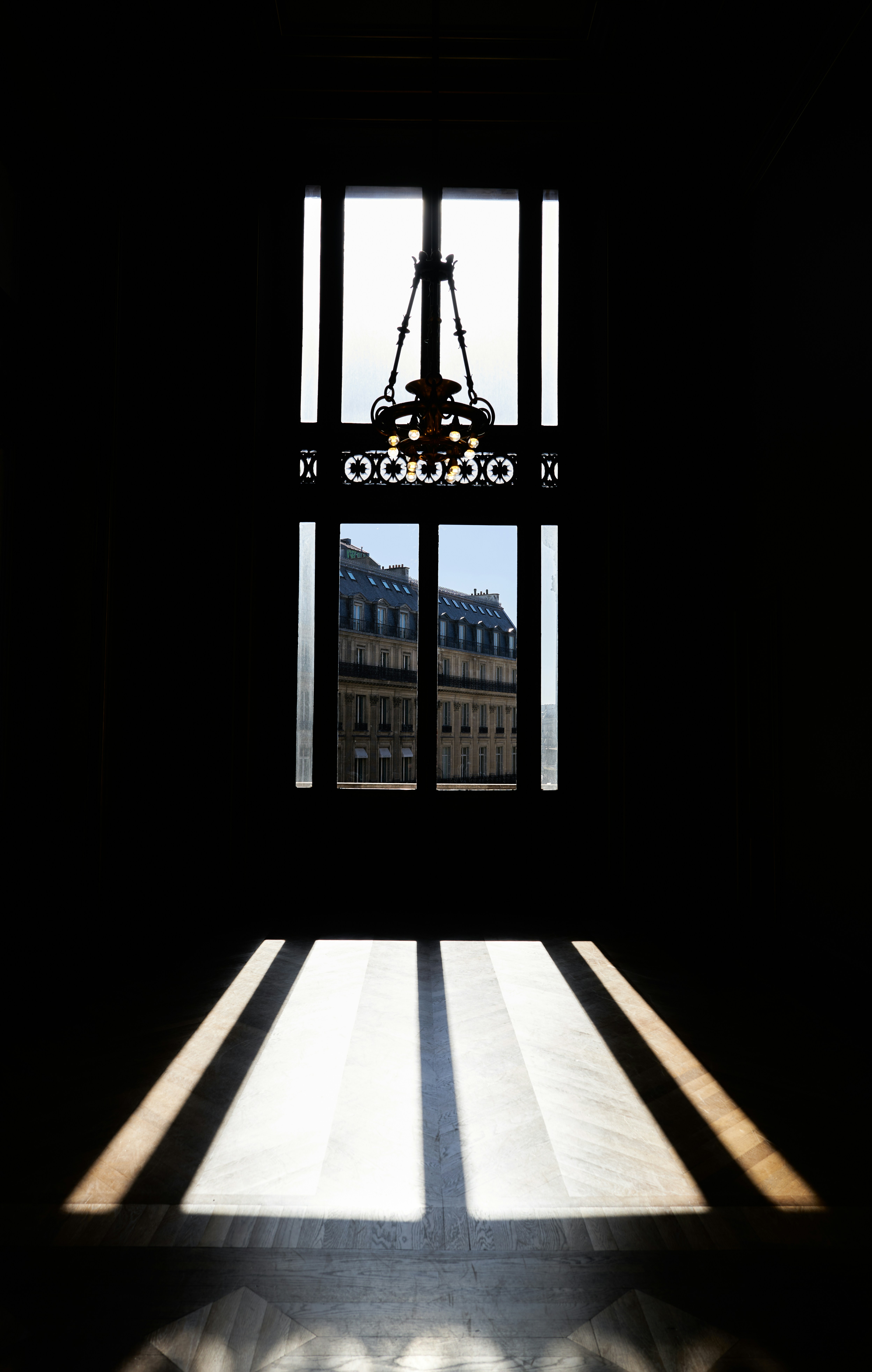 Chiaroscuro Window: Sunbeams Stretch Across a Silent Hall