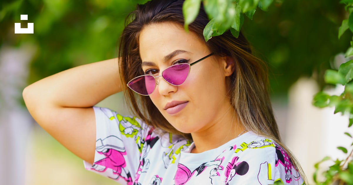 A Woman Wearing Pink Sunglasses Photo Free Sunglasses Image On Unsplash