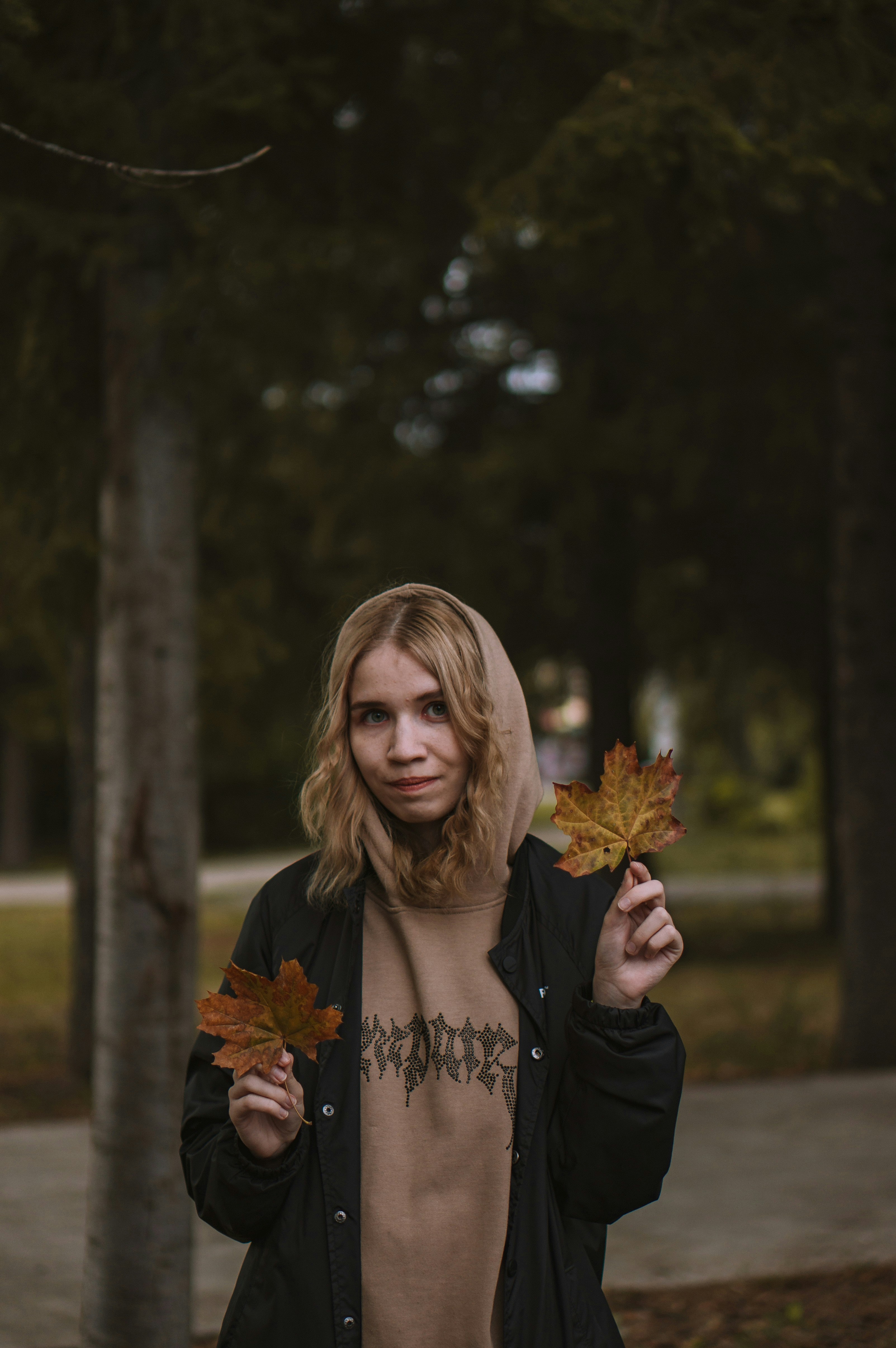a woman holding a leaf