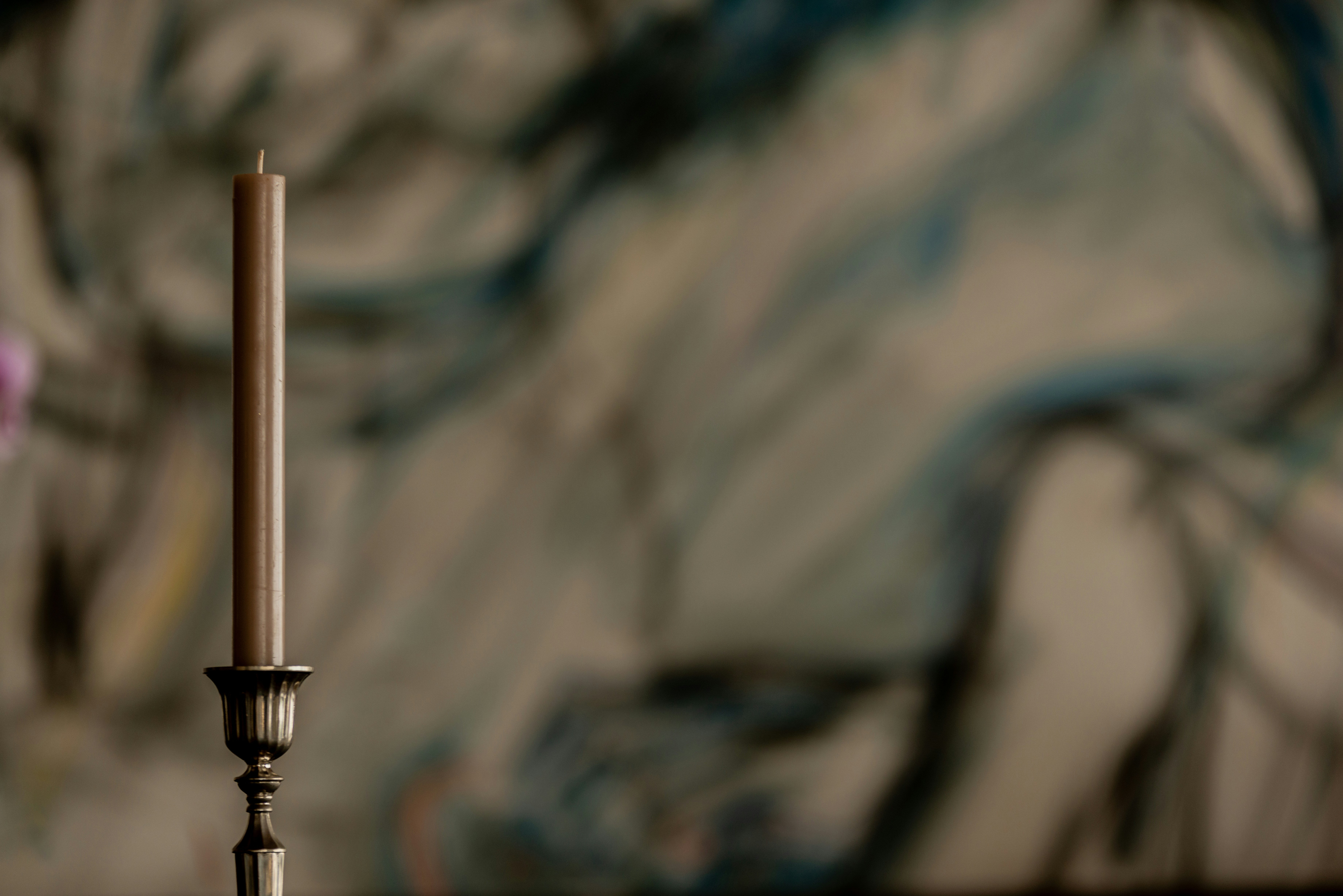 Candlelit Stillness: Brass Candlestick Against Velvet Backdrop