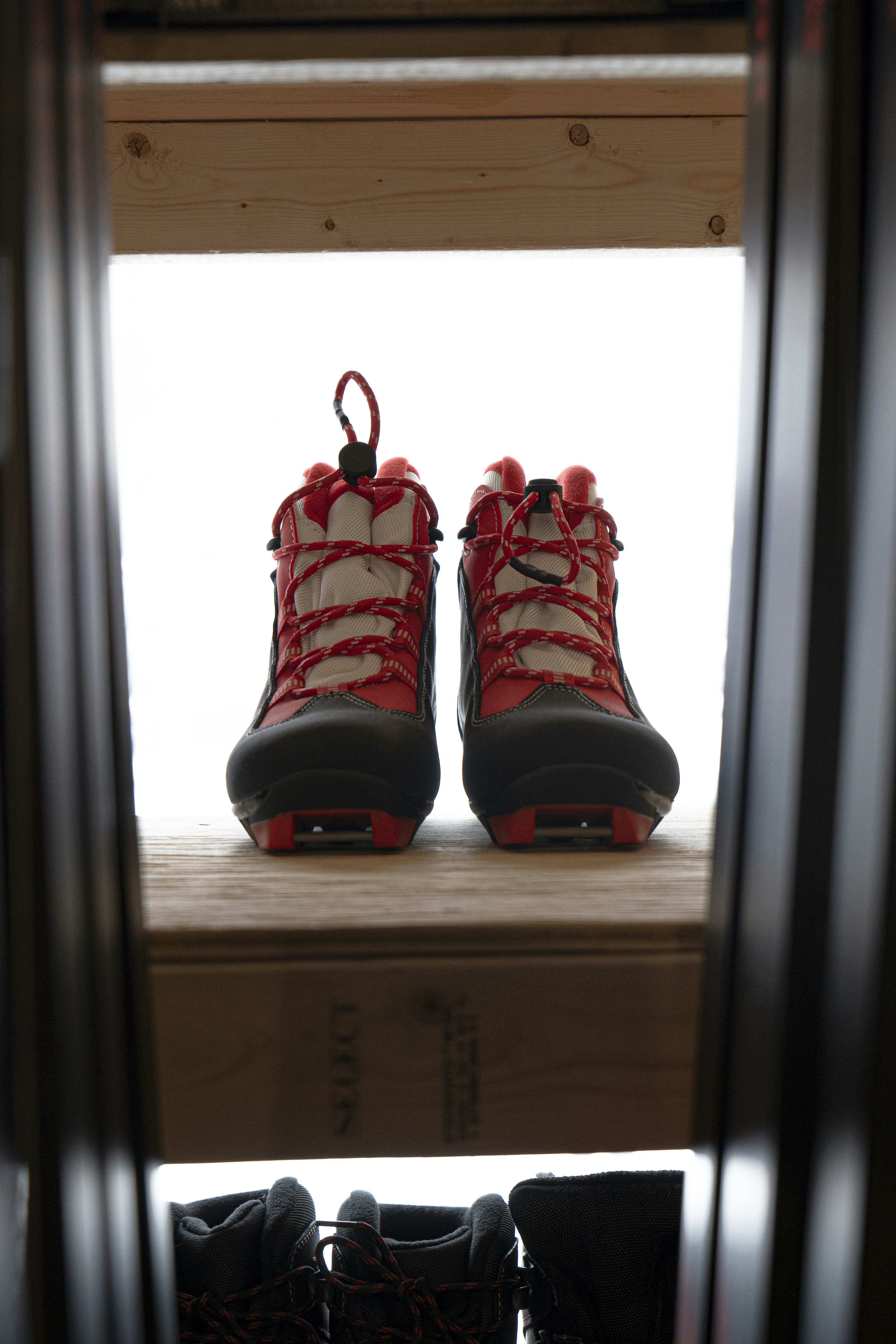 a pair of red shoes on a window sill