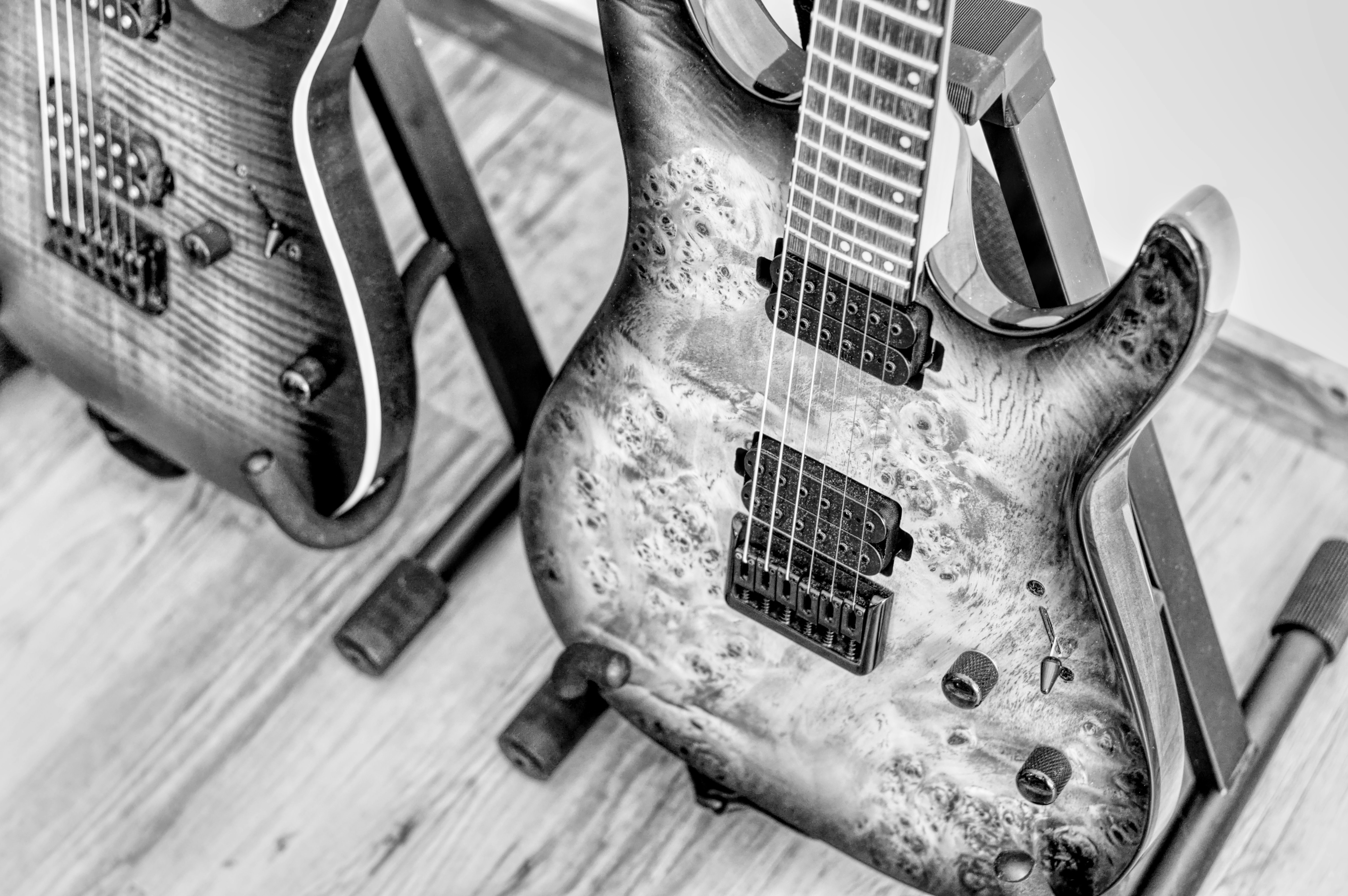 Weathered Six-String Duo Resting Against a Wooden Stage
