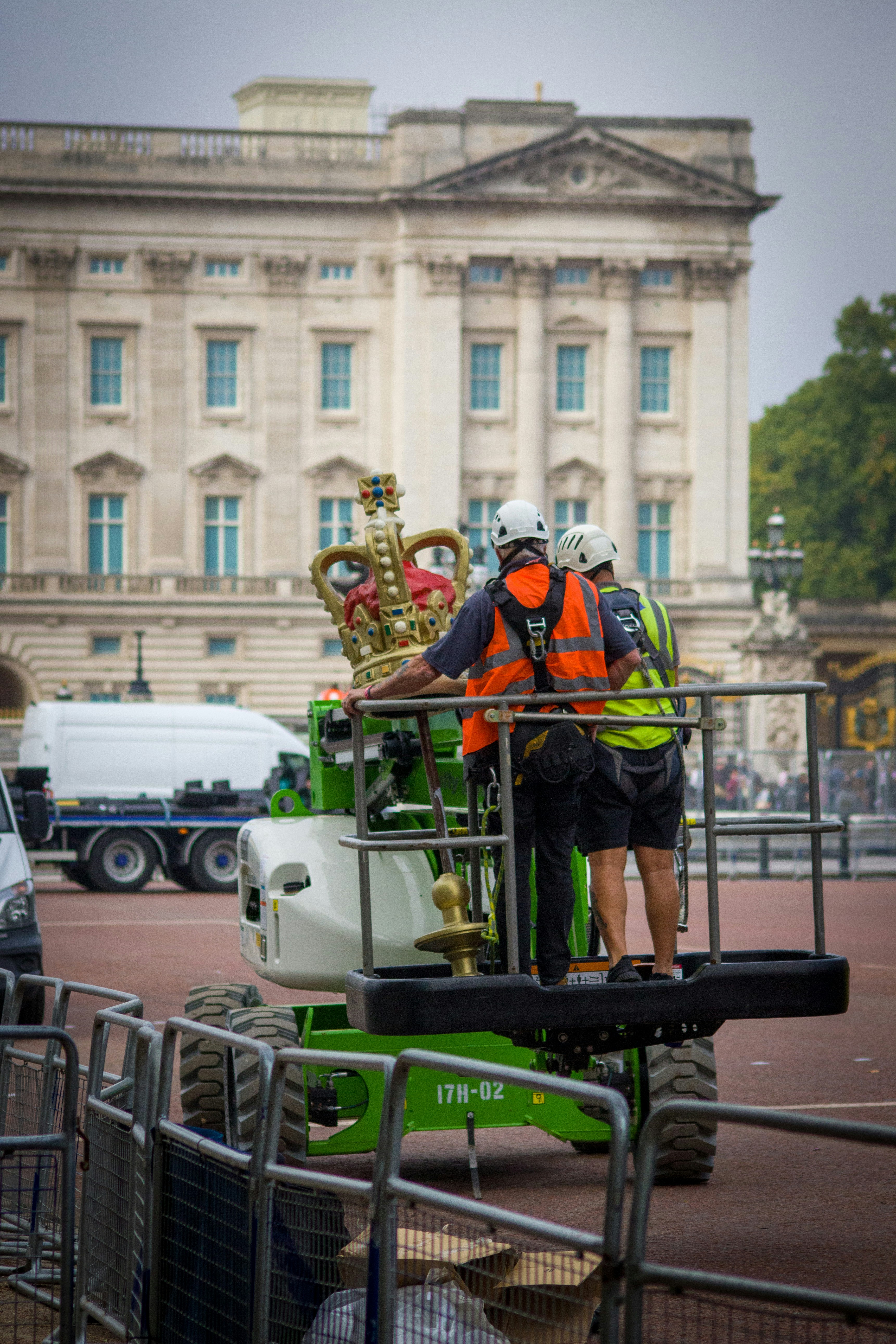 a group of men in safety vests on a ladder