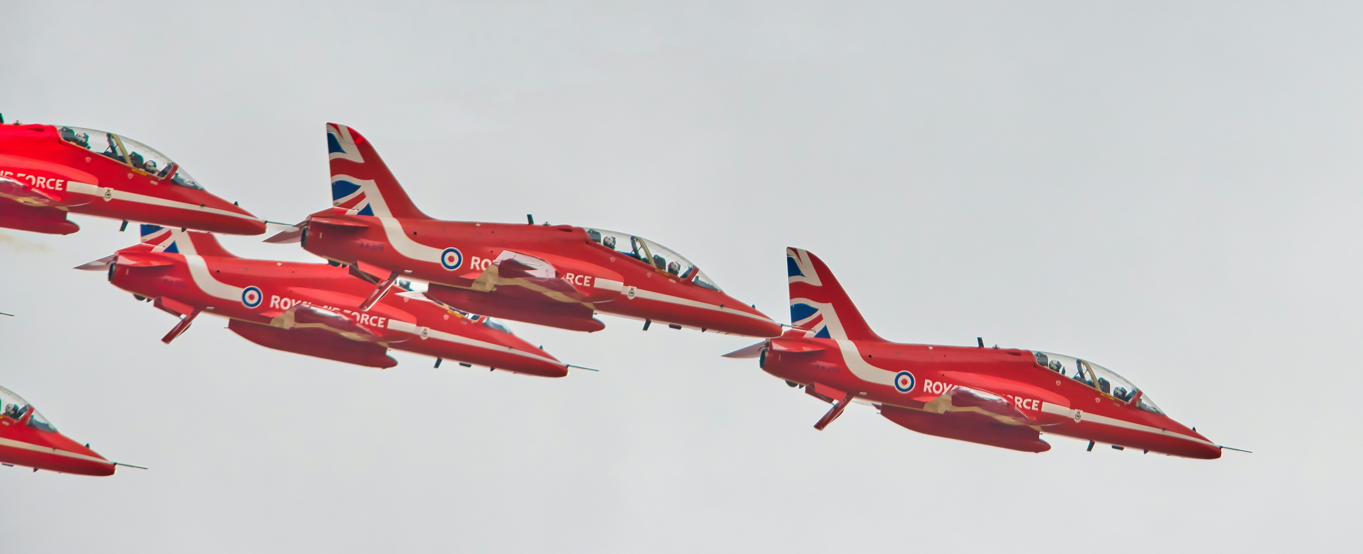A group of red airplanes flying in the sky photo – Free Aircraft Image ...