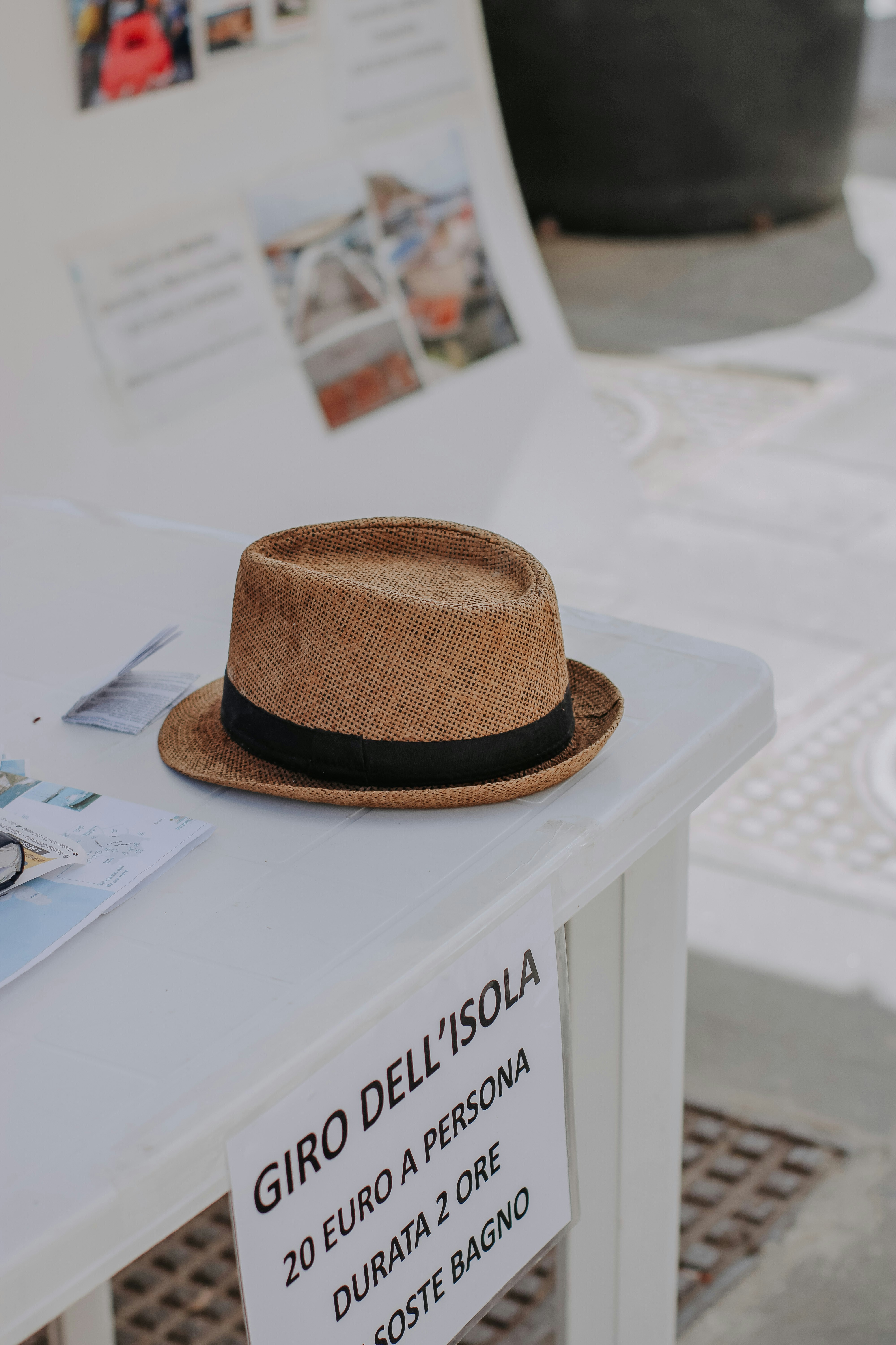  straw hat resting on a white vendor table at a street stall