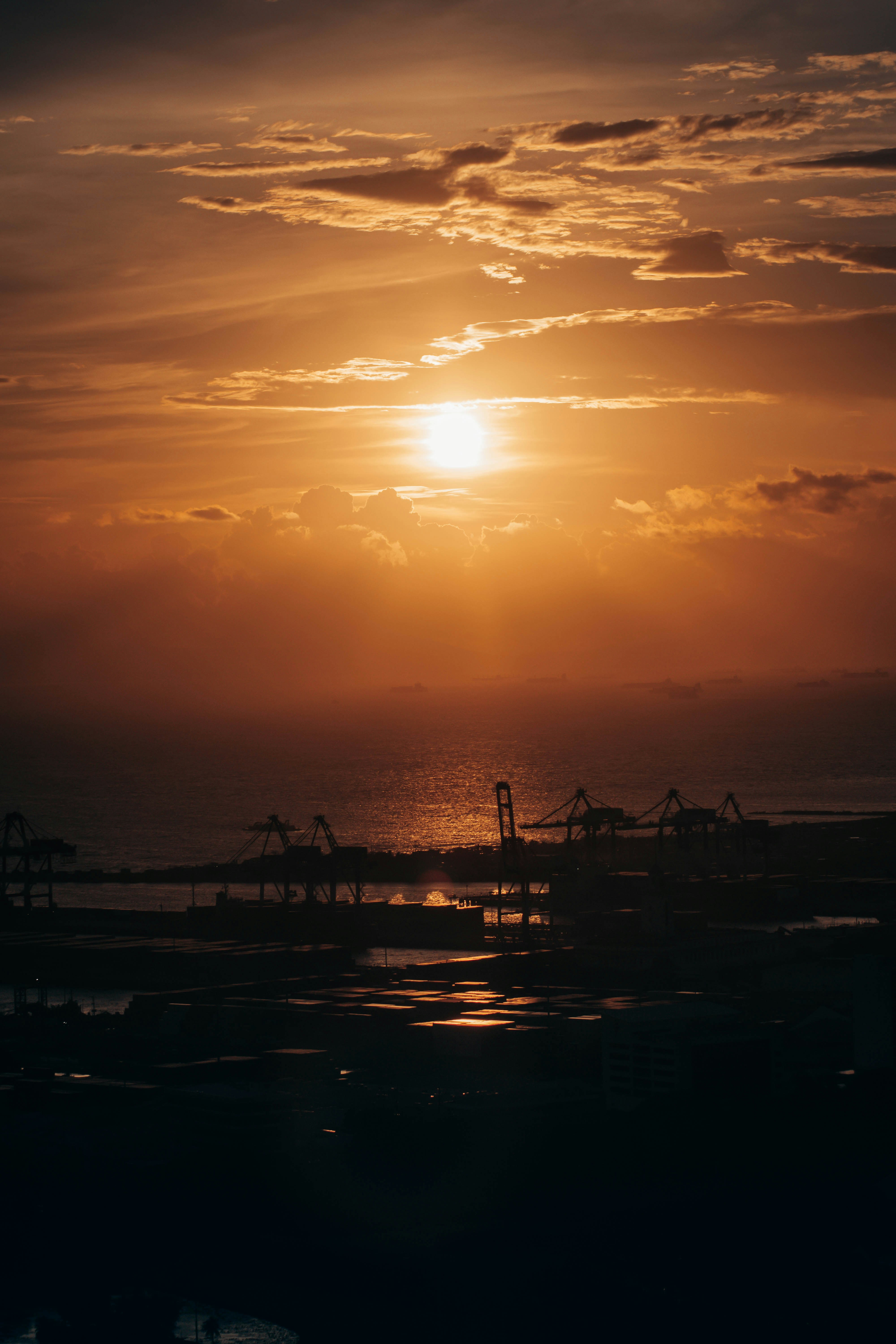 Crimson Harbor at Dusk: Silhouettes Against a Glassy Sea