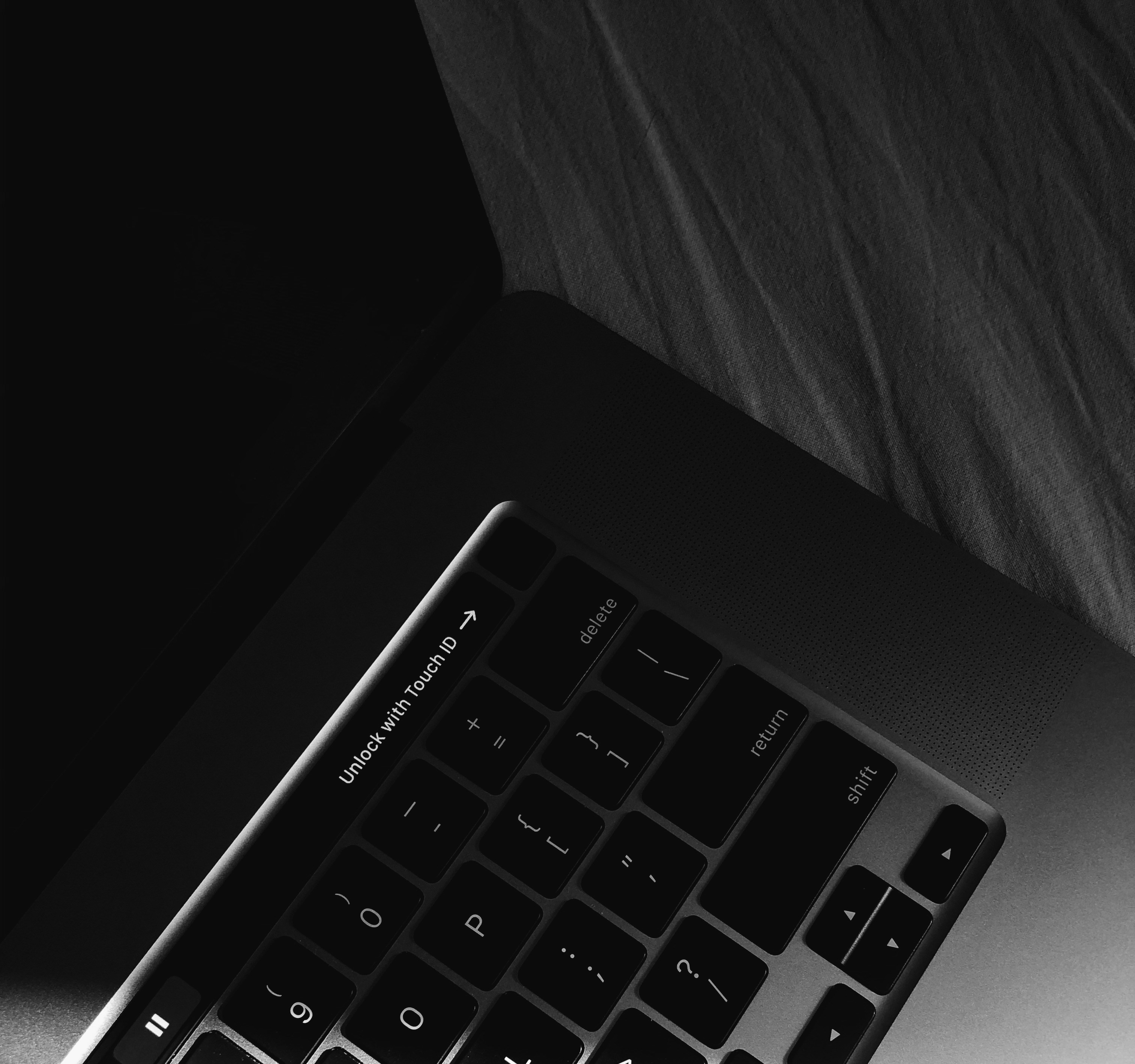 Close-up of a laptop keyboard in soft, ambient lighting.