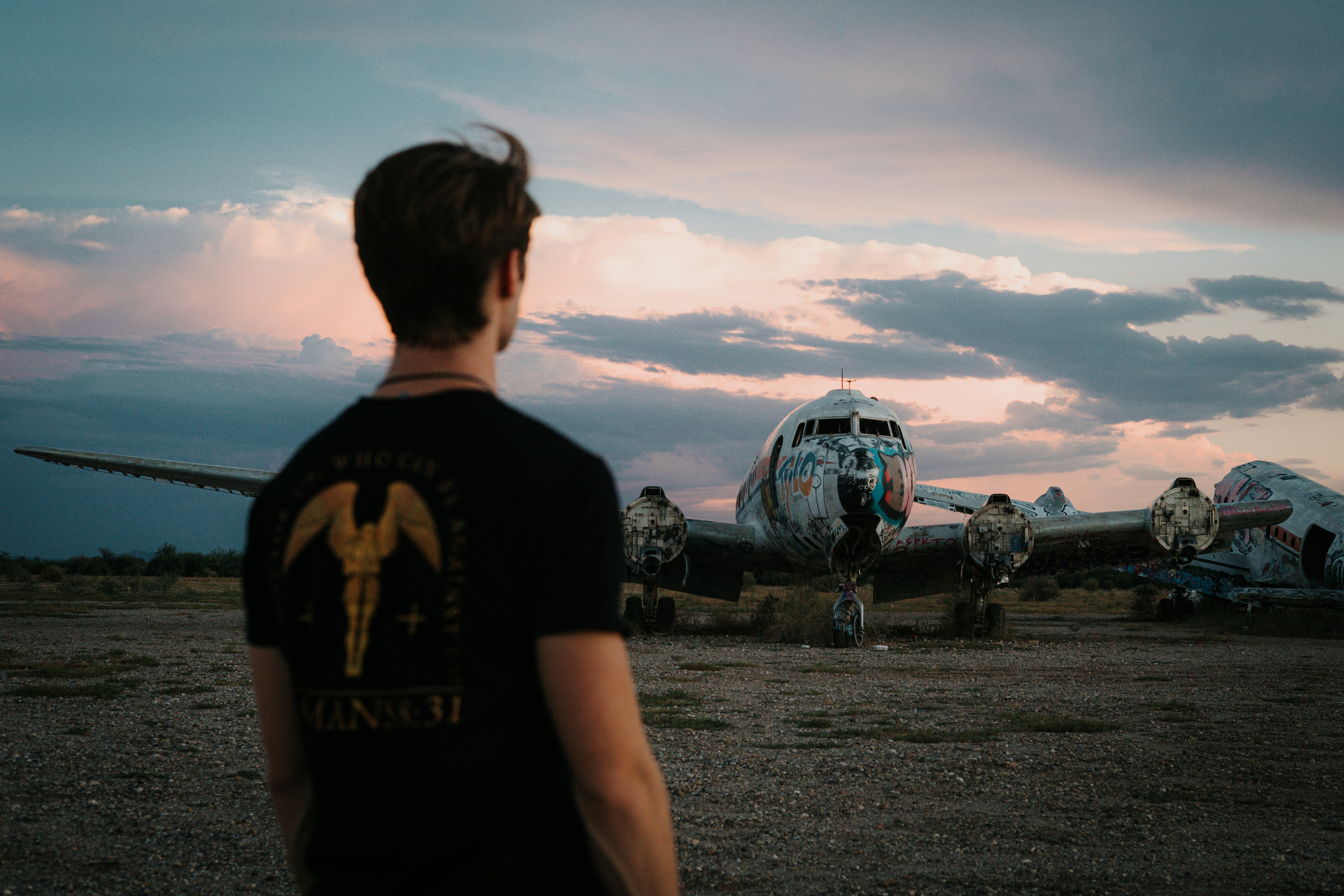 Abandoned Sky: A Lone Figure Faces a Silent Avro at Dusk
