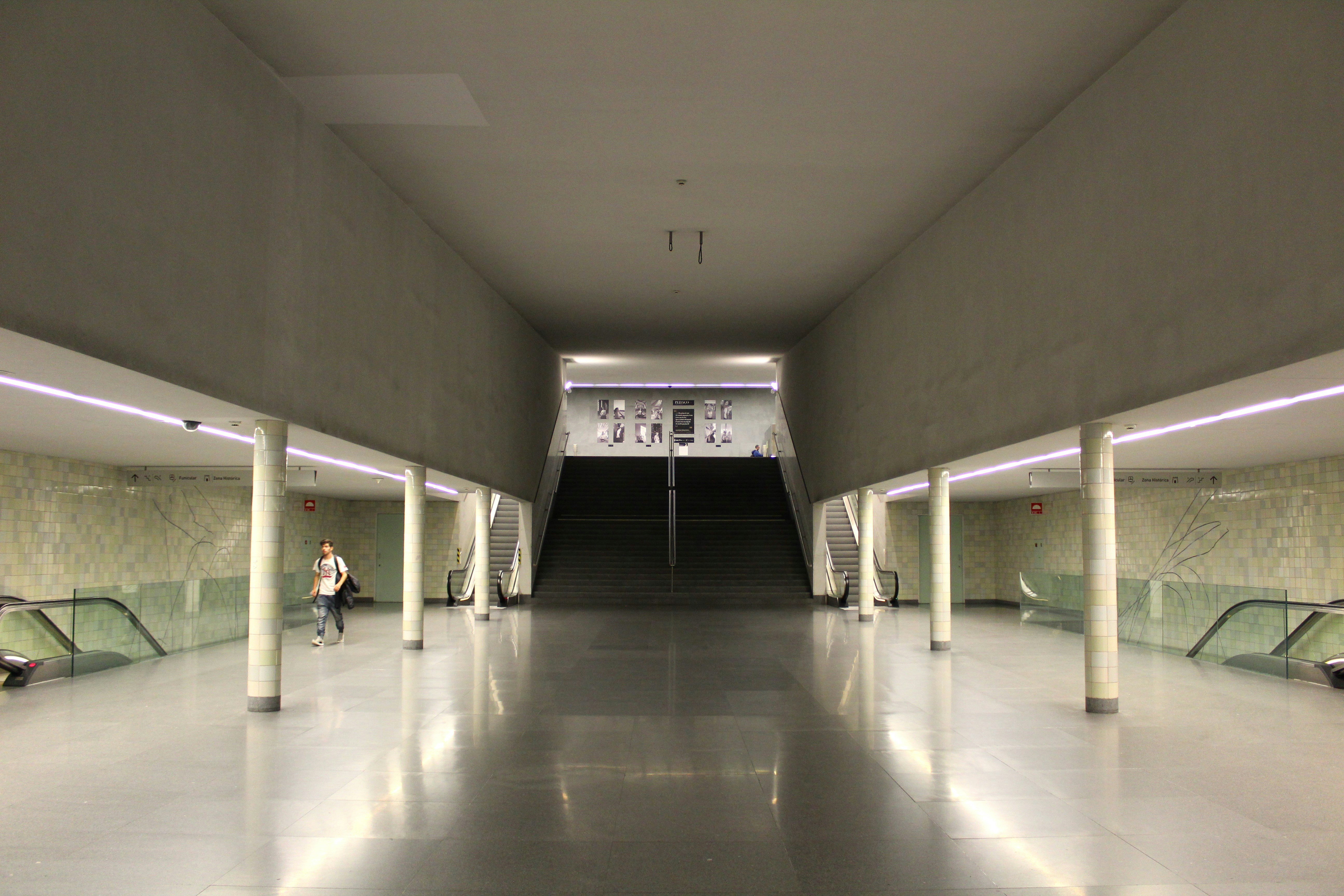 A person walking down a hall photo – Free Architecture Image on Unsplash