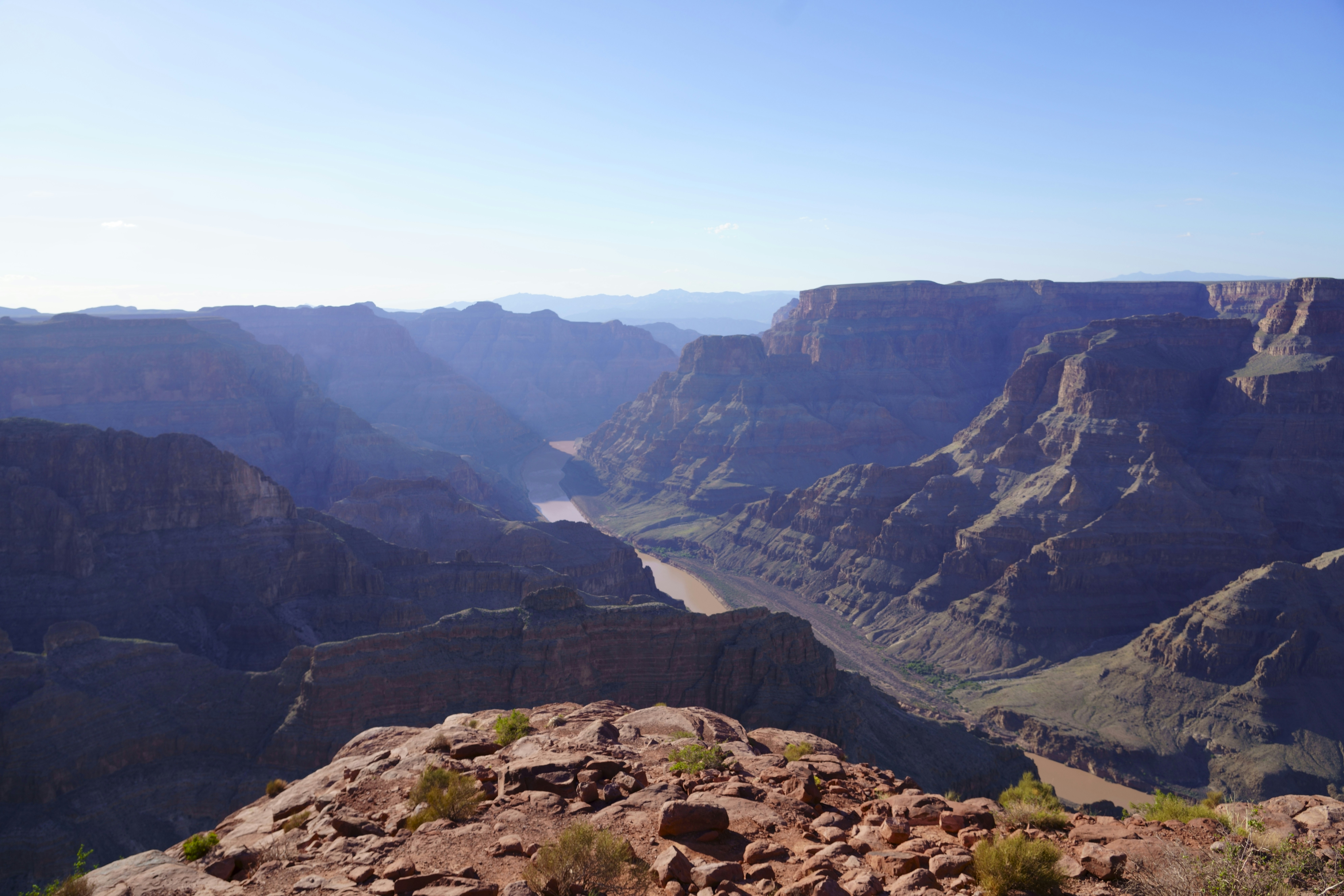 a rocky canyon with a blue sky