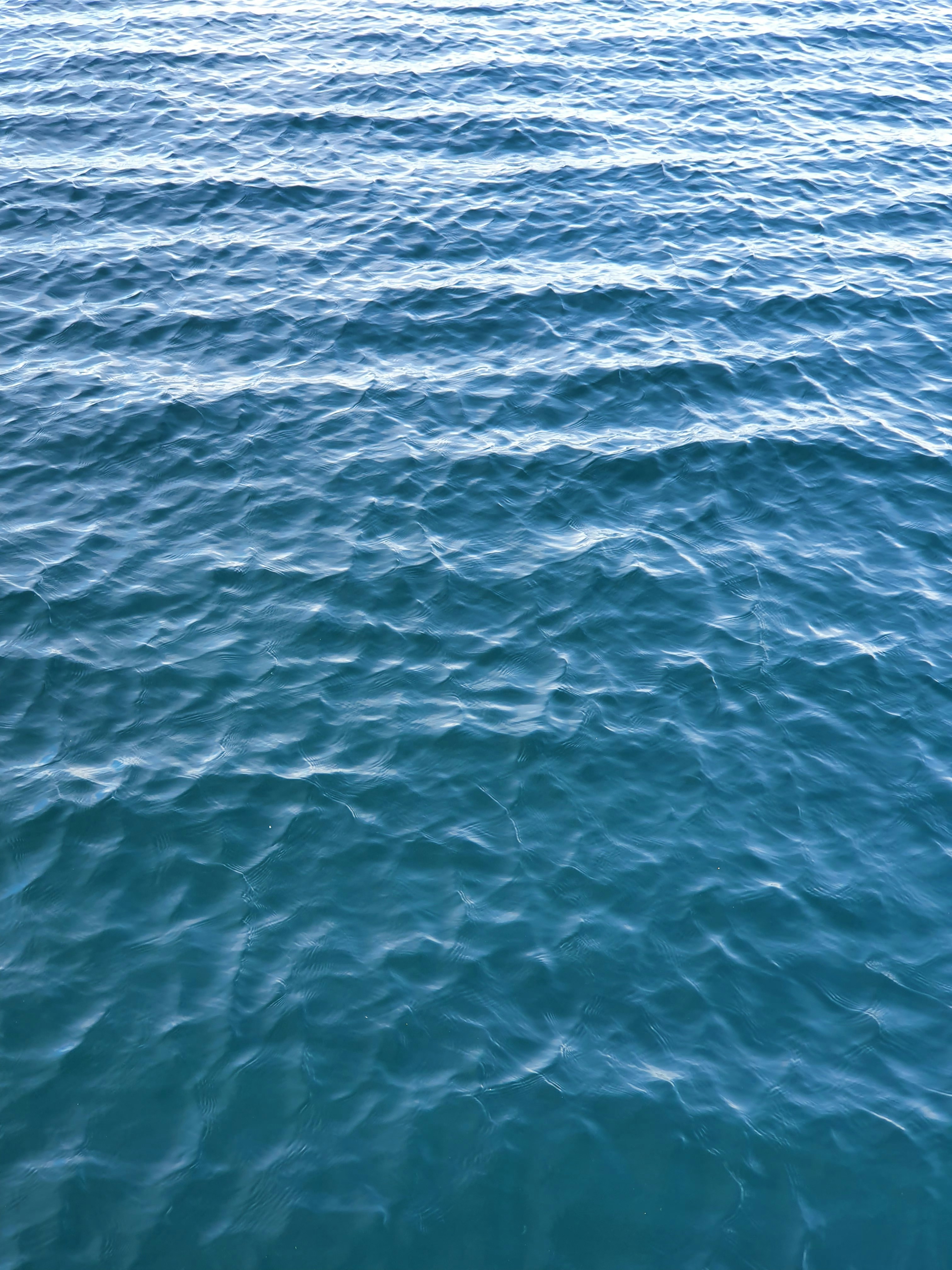 Gentle ripples create a mesmerizing pattern on the surface of the water, reflecting light and color variations.