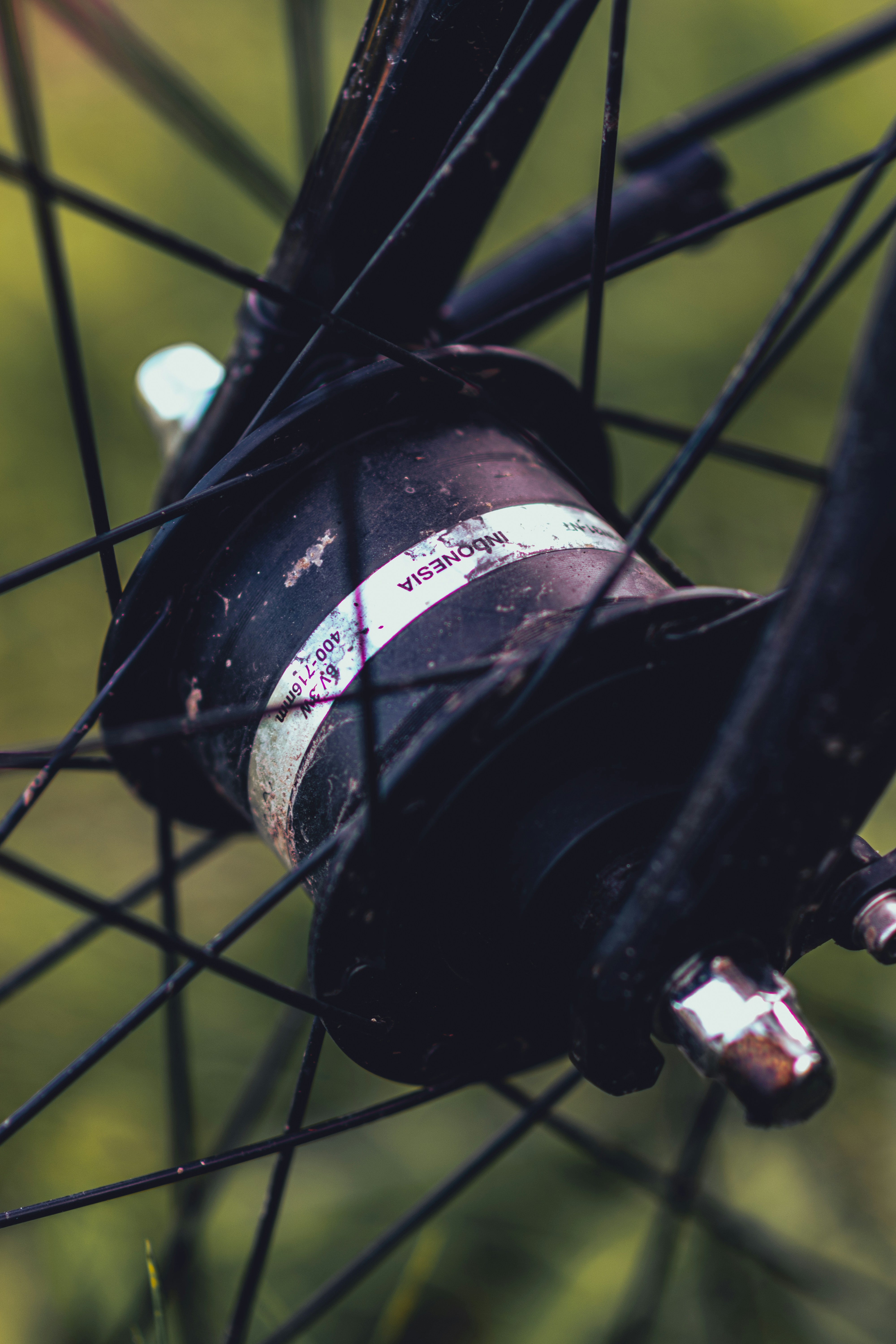 Tangled Spokes, Worn Hub: Macro Portrait of a Bicycle's Core