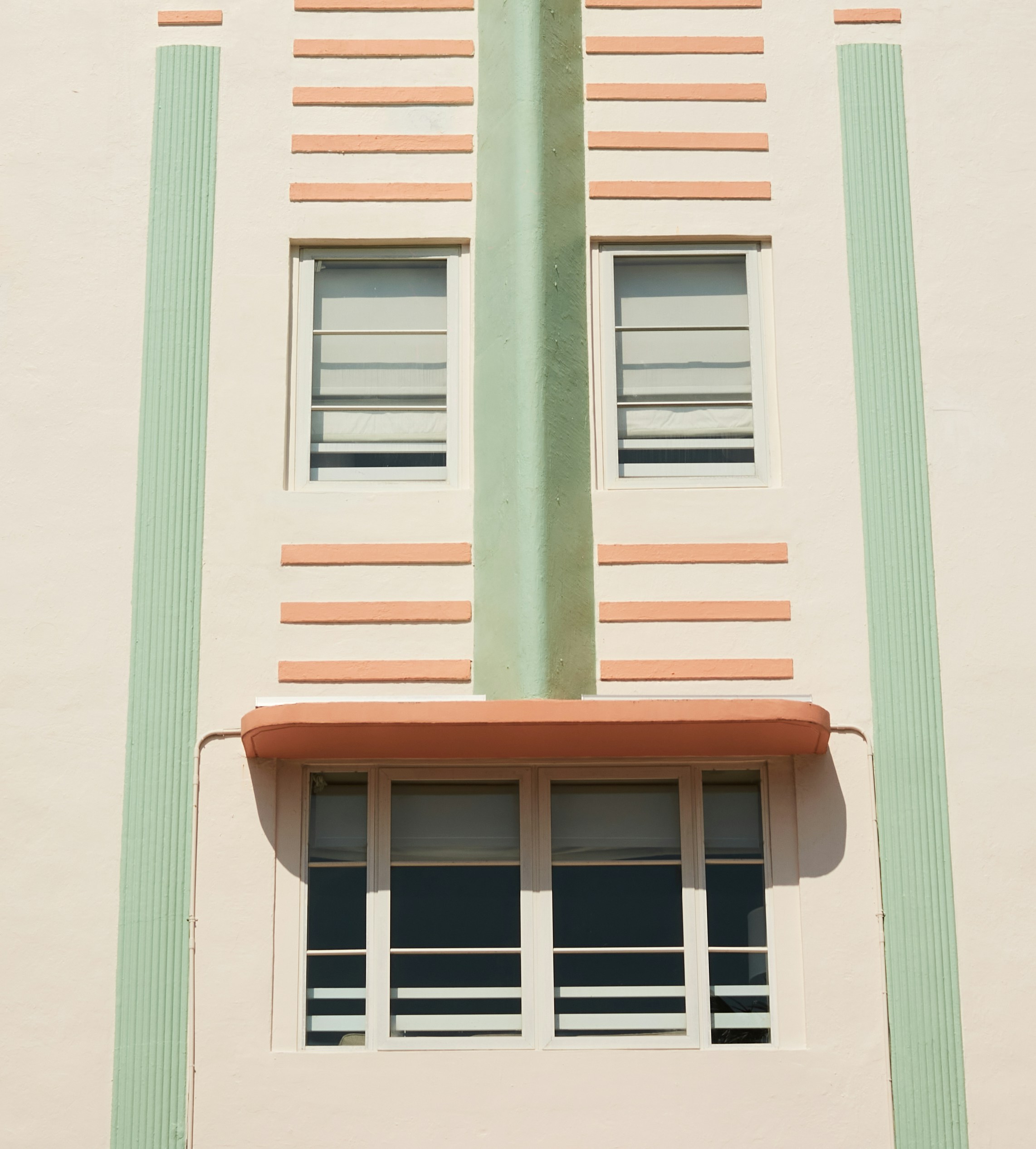 Pastel Pillars at Noon: A Mint-and-Peach Facade
