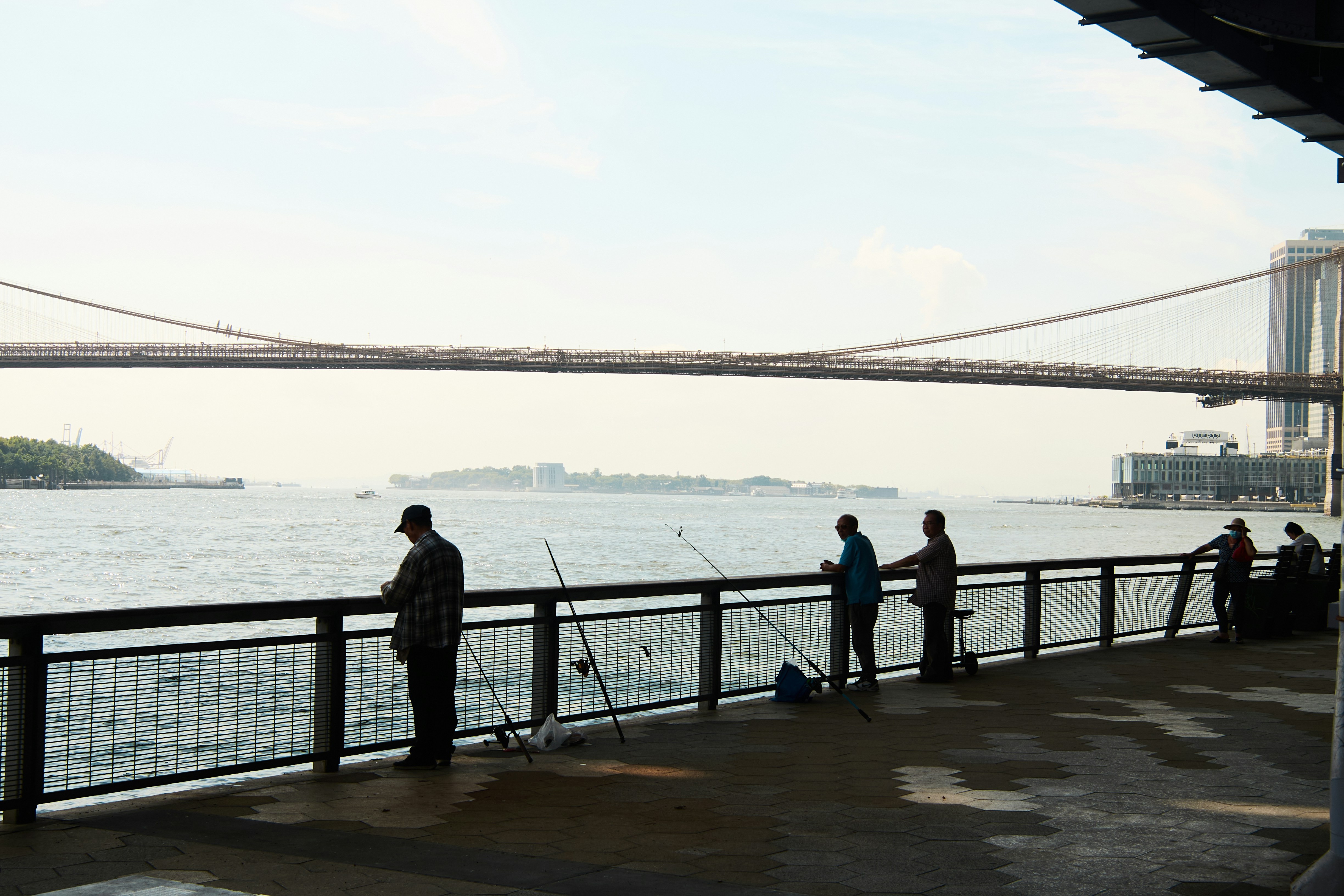 A group of people standing on a dock by a body of water photo – Free ...