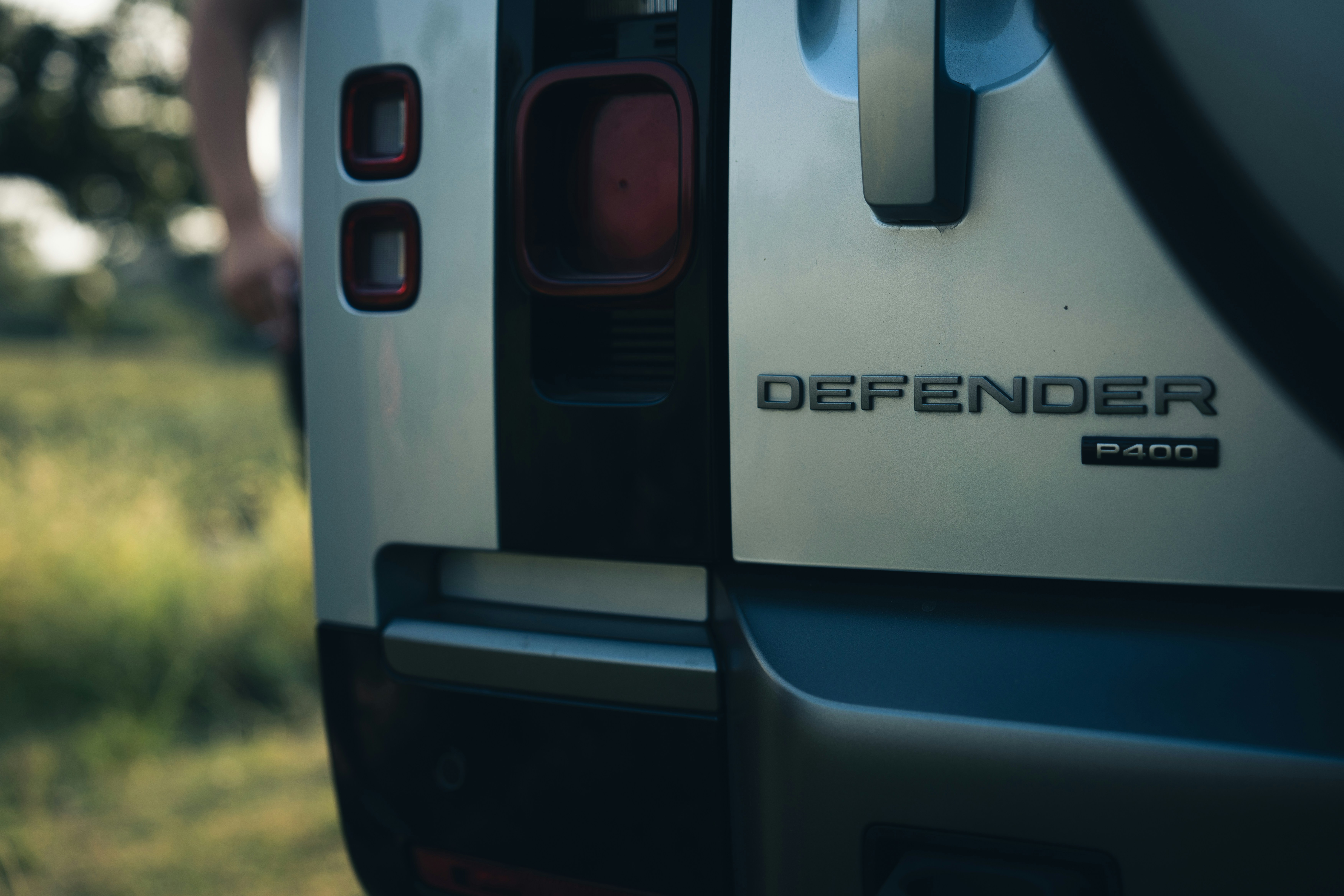 Tailgate Portrait: Defender P400 Badge Under Quiet Afternoon Light