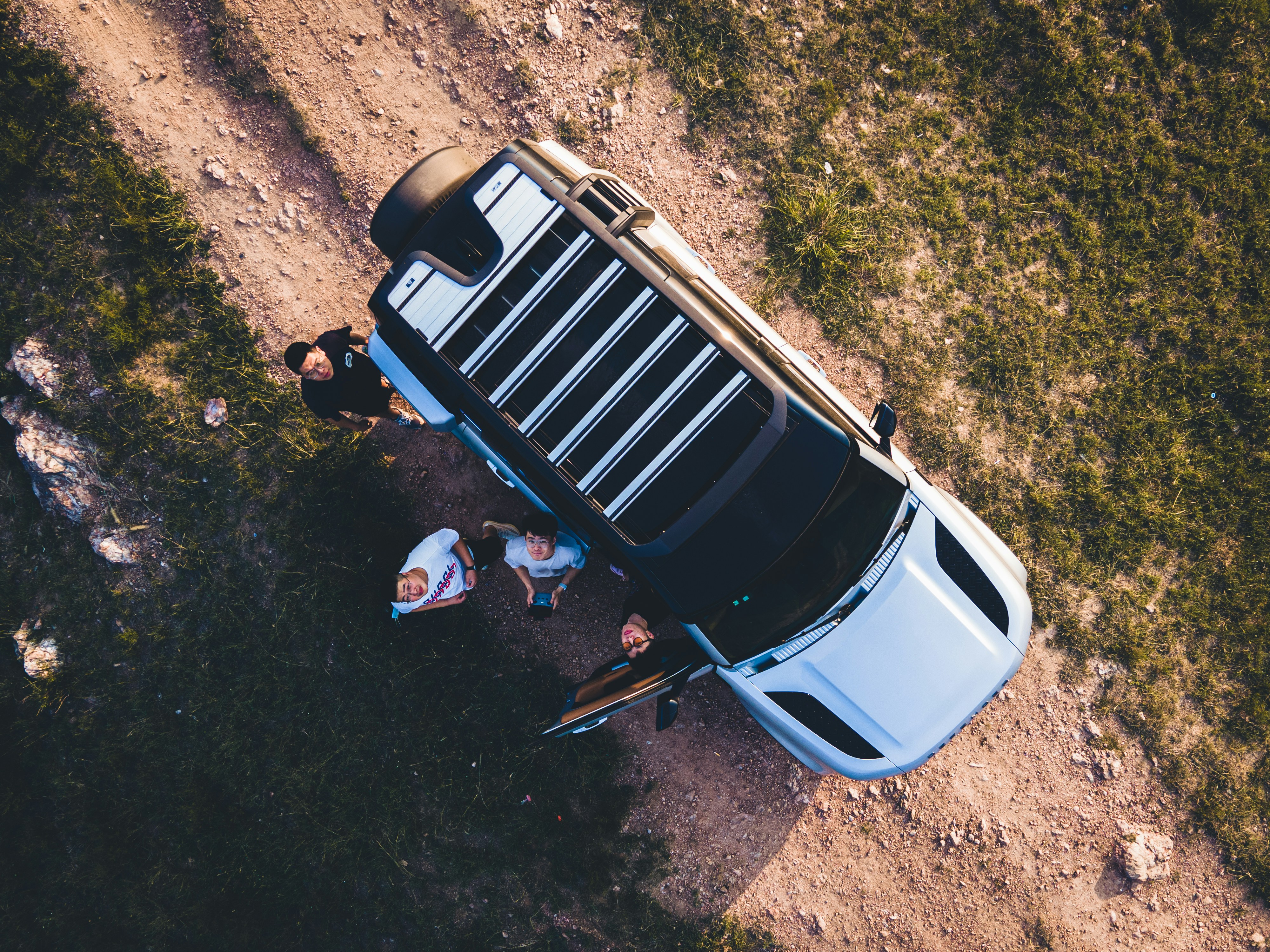 Dirt and Drive: An Aerial Portrait of a White SUV on a Rugged Track