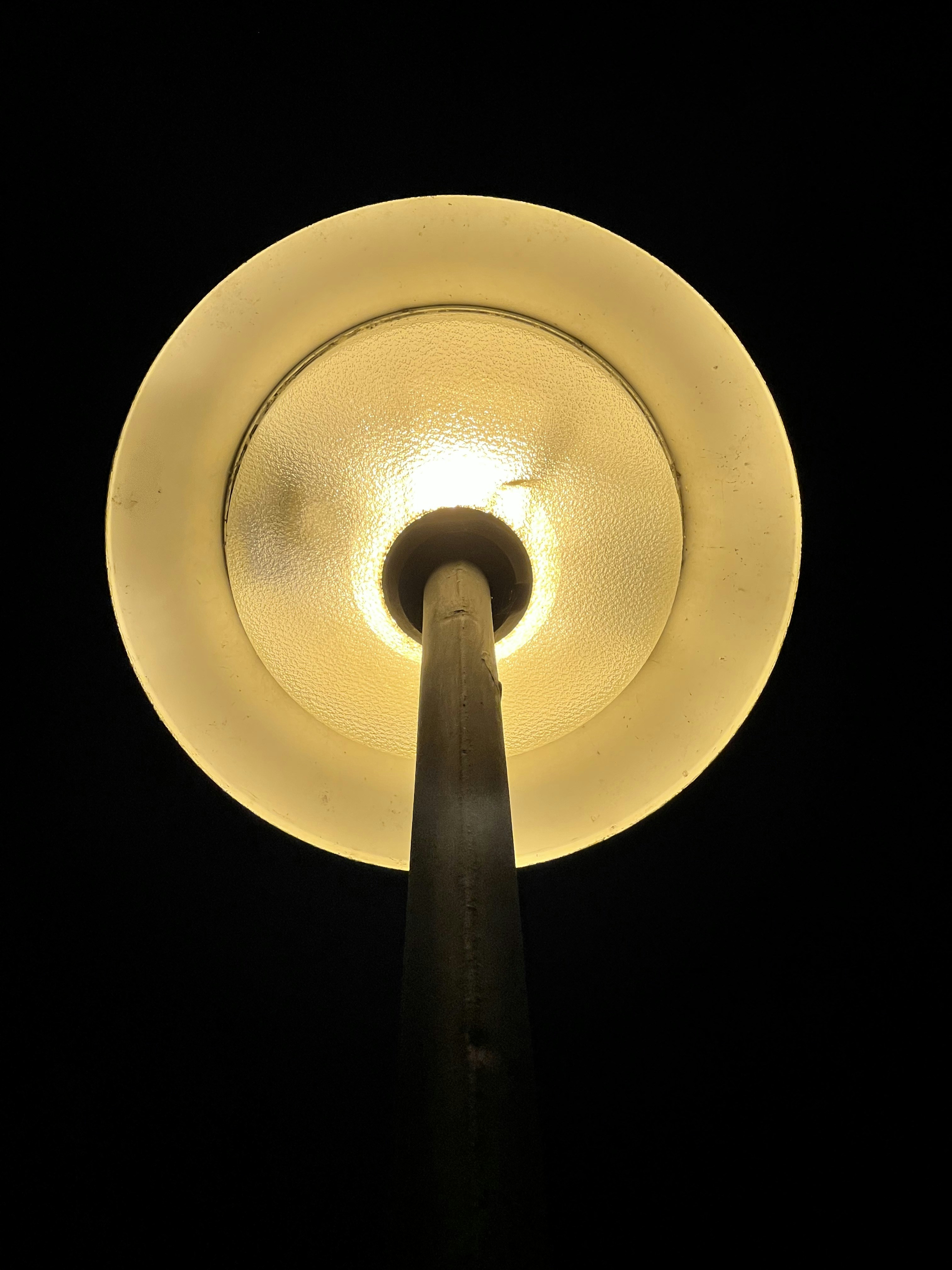 Halo Above the Street: An Upward Look at a Warm Streetlamp