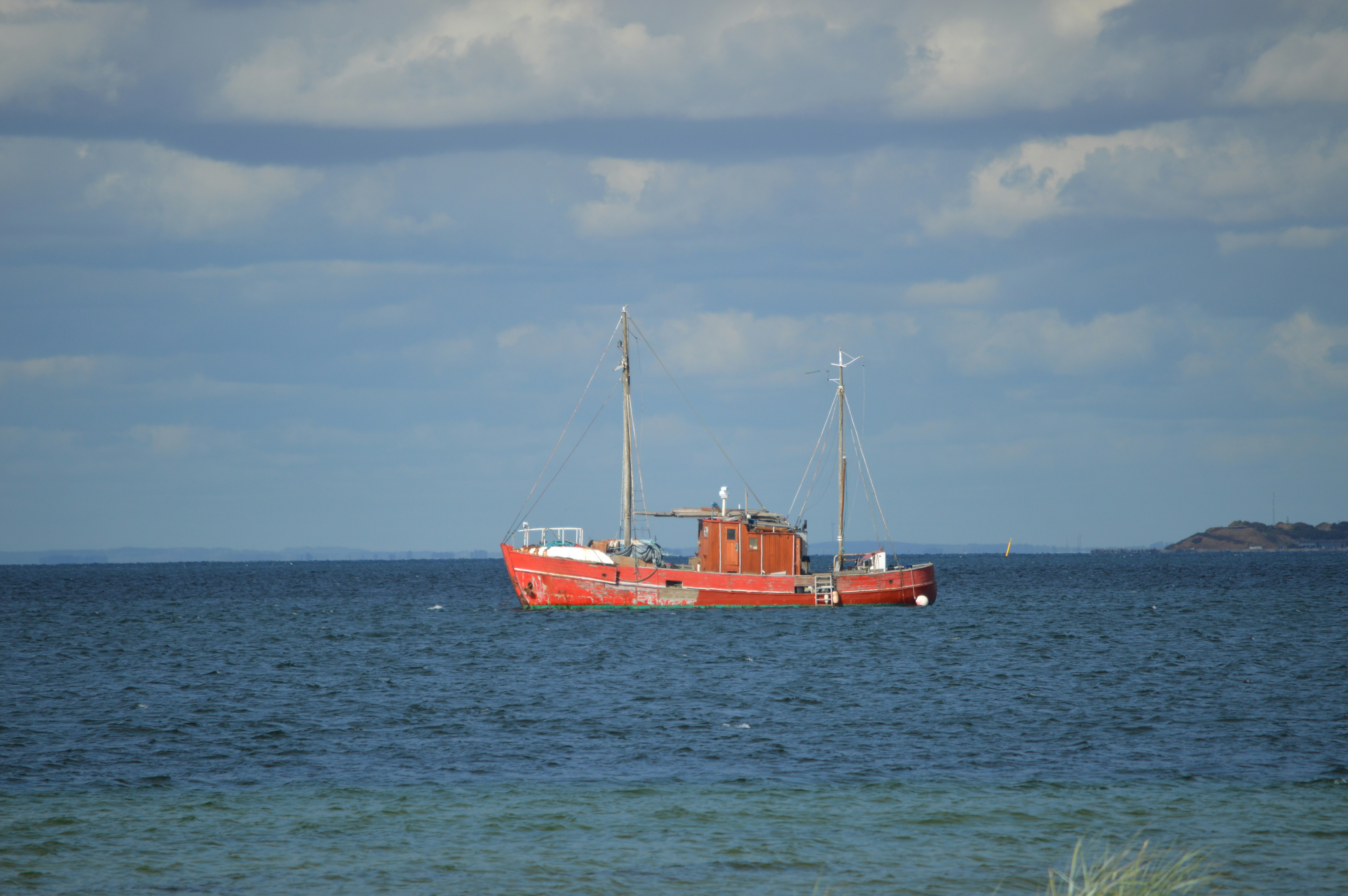 Ember on the Sea: A Red Vessel in the Quiet Blue