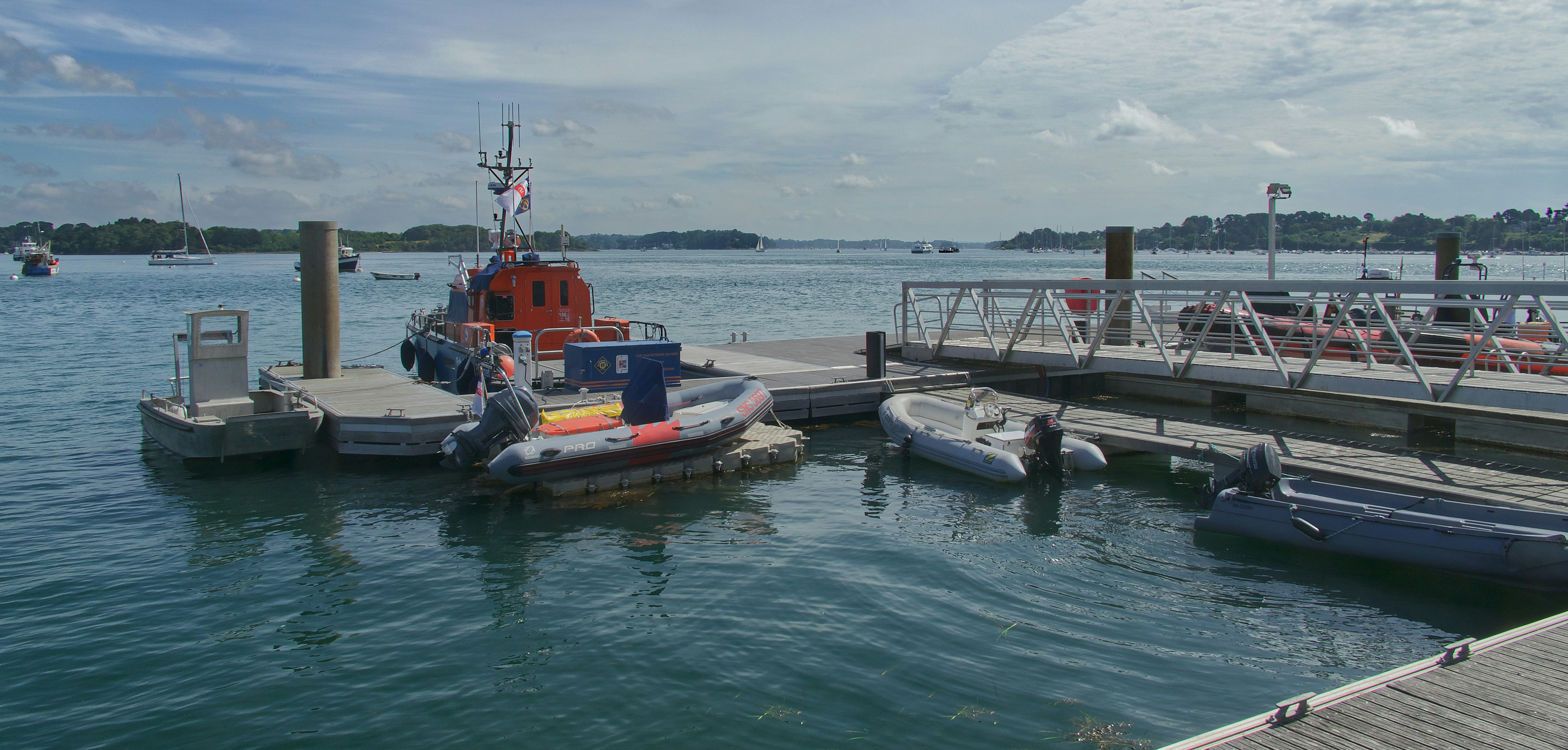 Red Tug at the Quiet Harbor: Docks, Boats, and Glassy Blue Water
