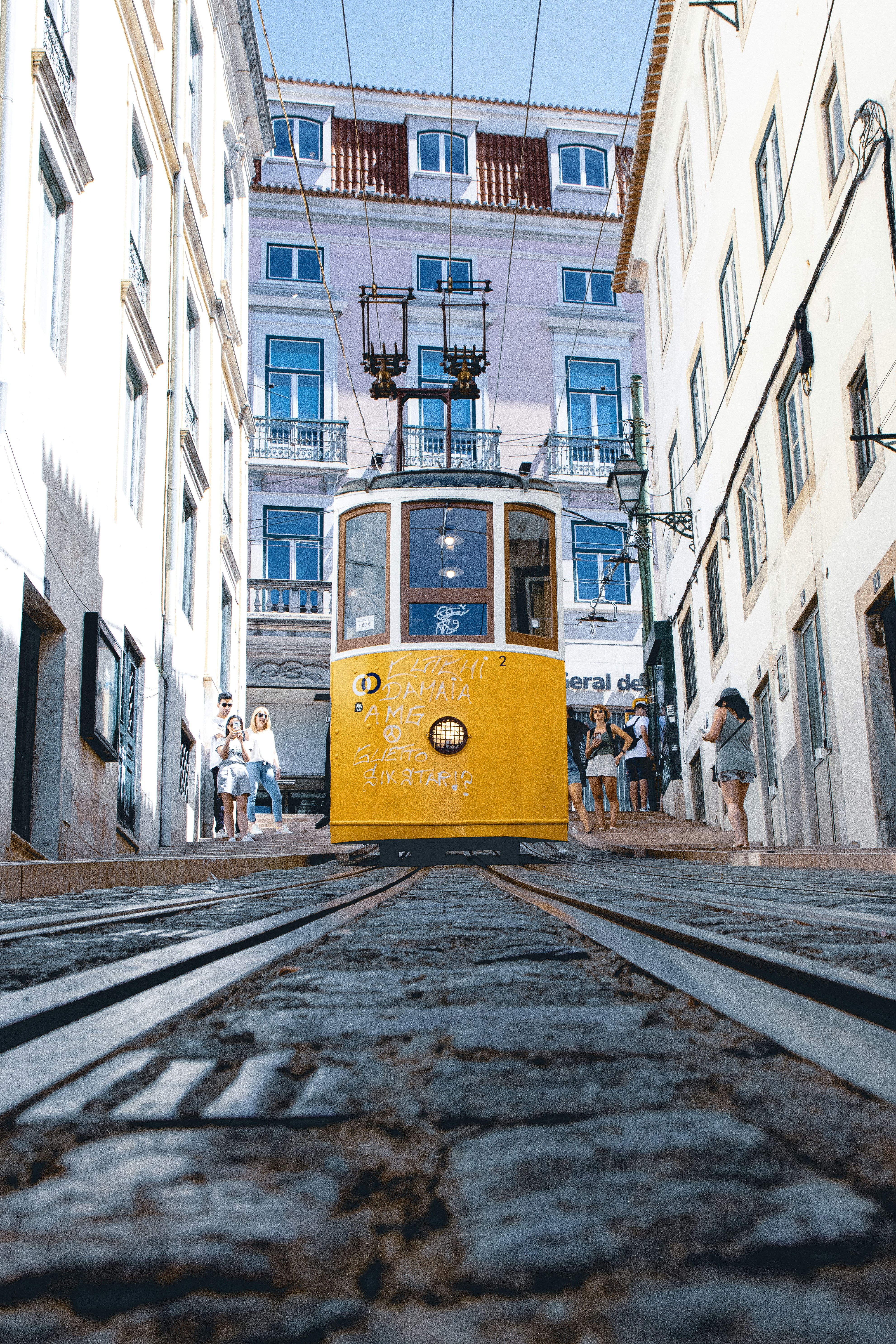 a yellow train on the tracks