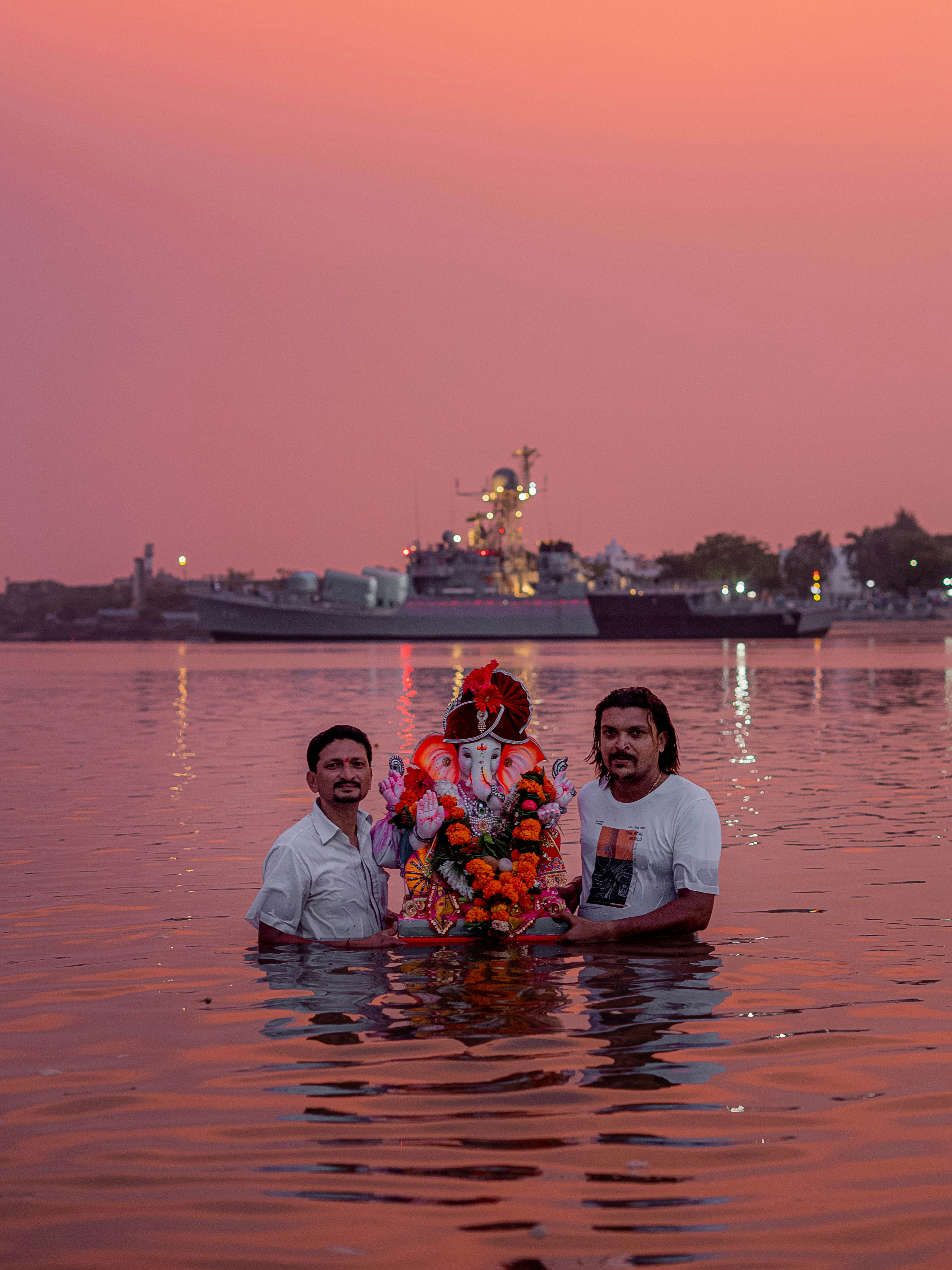 Manya Surve et al. standing next to a body of water photo – Free Image ...